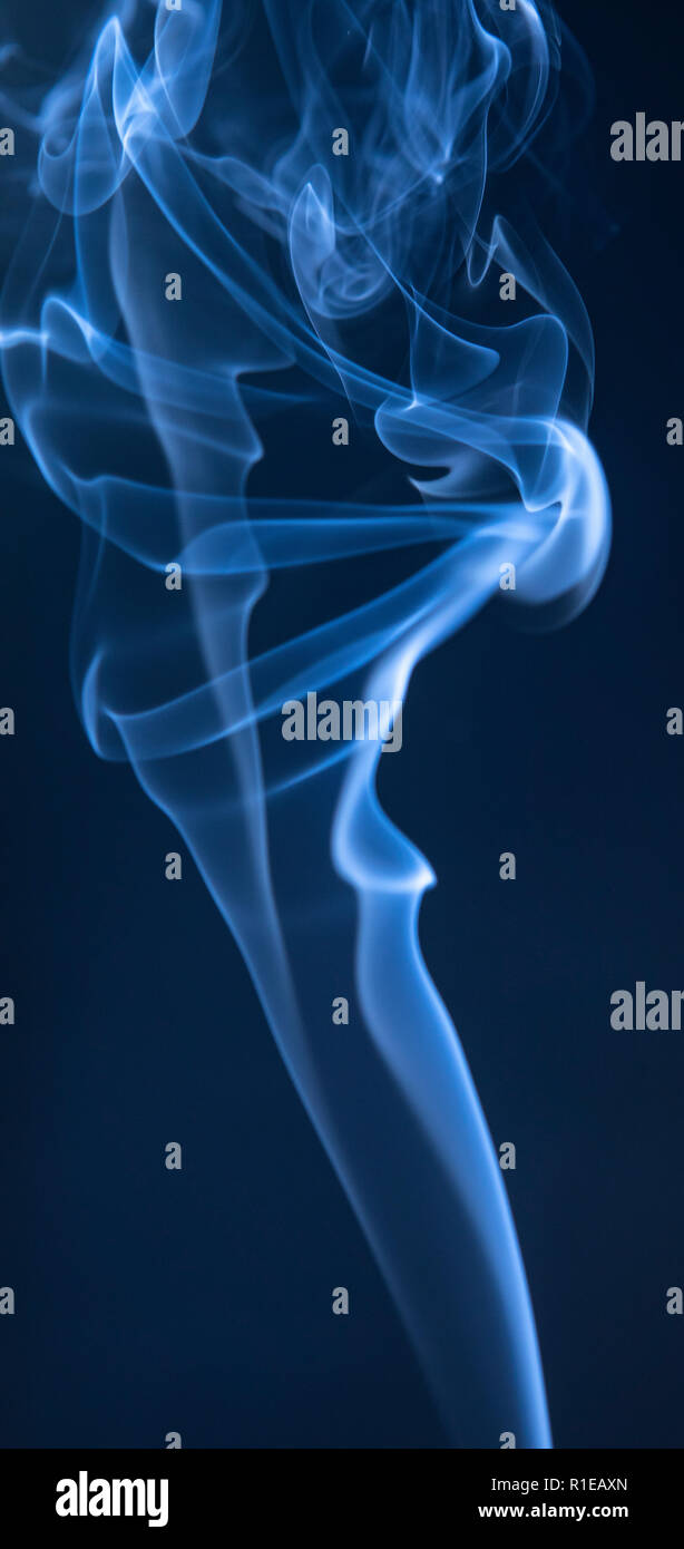 Abstract blue smoke swirls on dark background Stock Photo - Alamy
