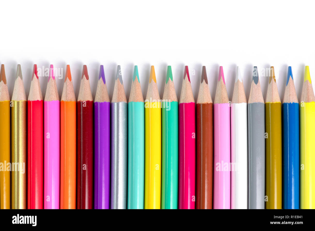 a row of vibrant coloured pencils with clean tips on a white background ...