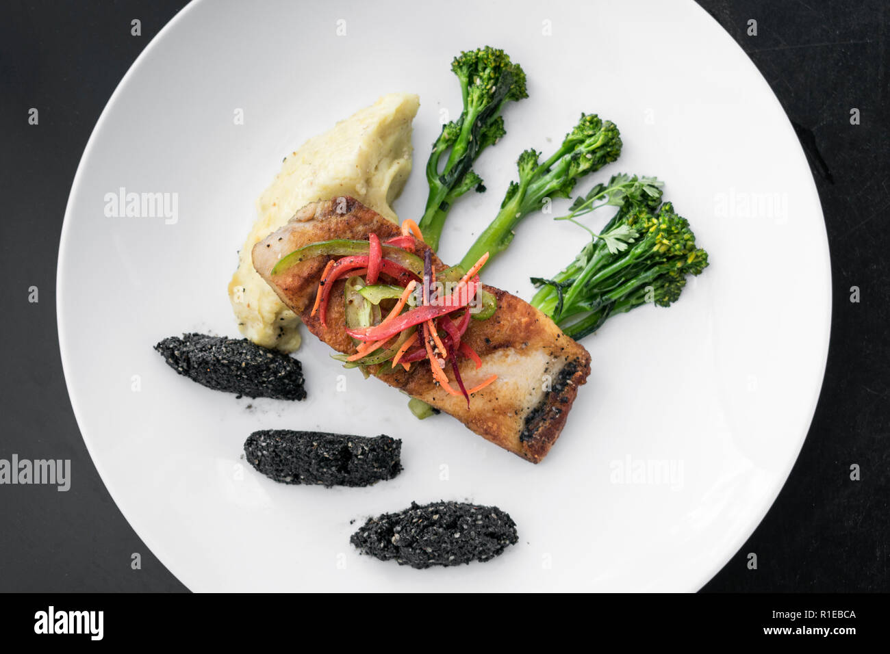 red snapper fish fillet with vegetables and black rice with black ...