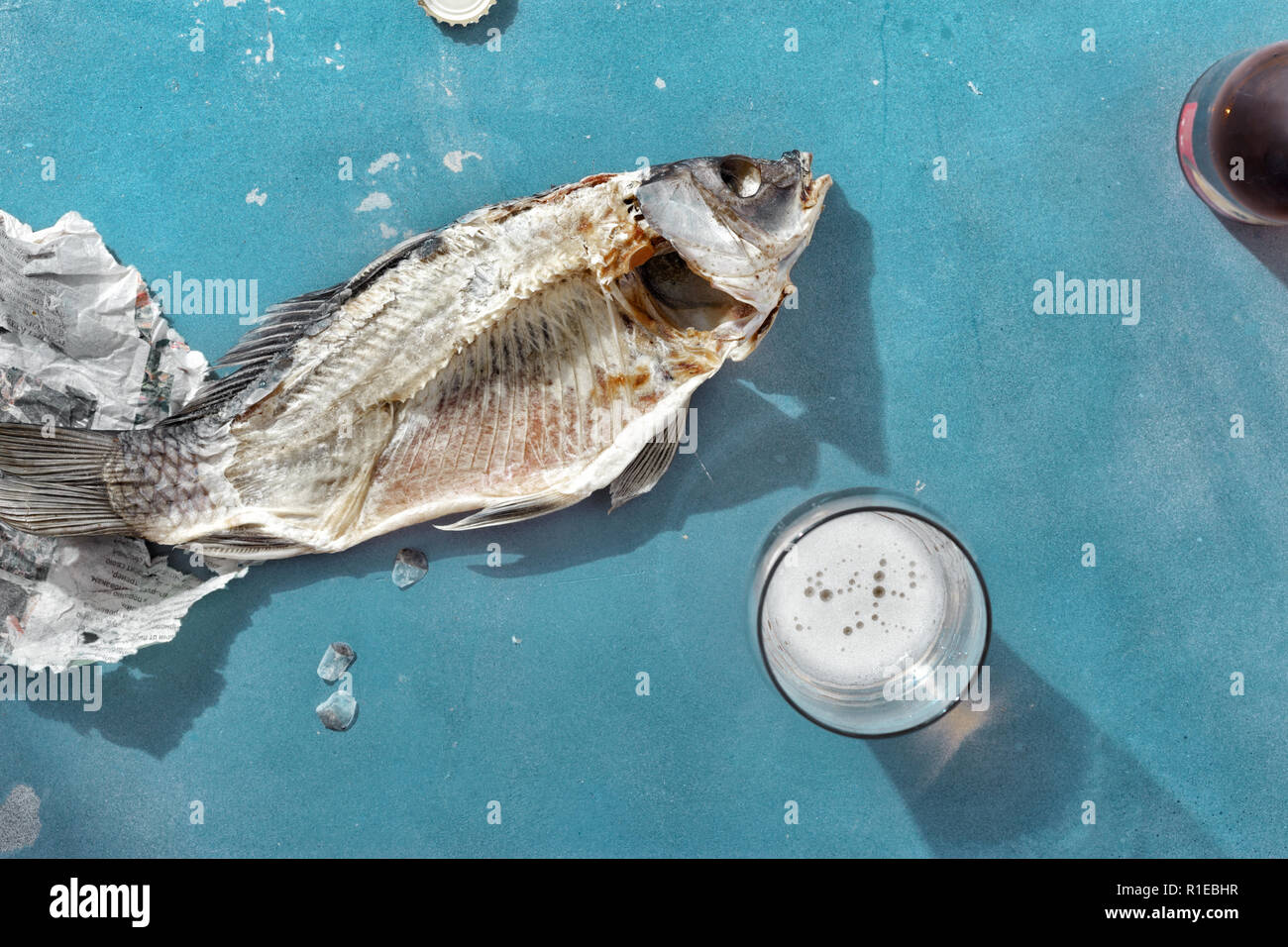 Dried fish with beer on stone blue background top view Stock Photo - Alamy