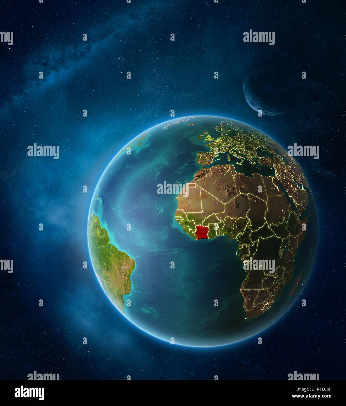 Planet Earth with highlighted Ivory Coast in space with Moon and Milky Way. Visible city lights ...