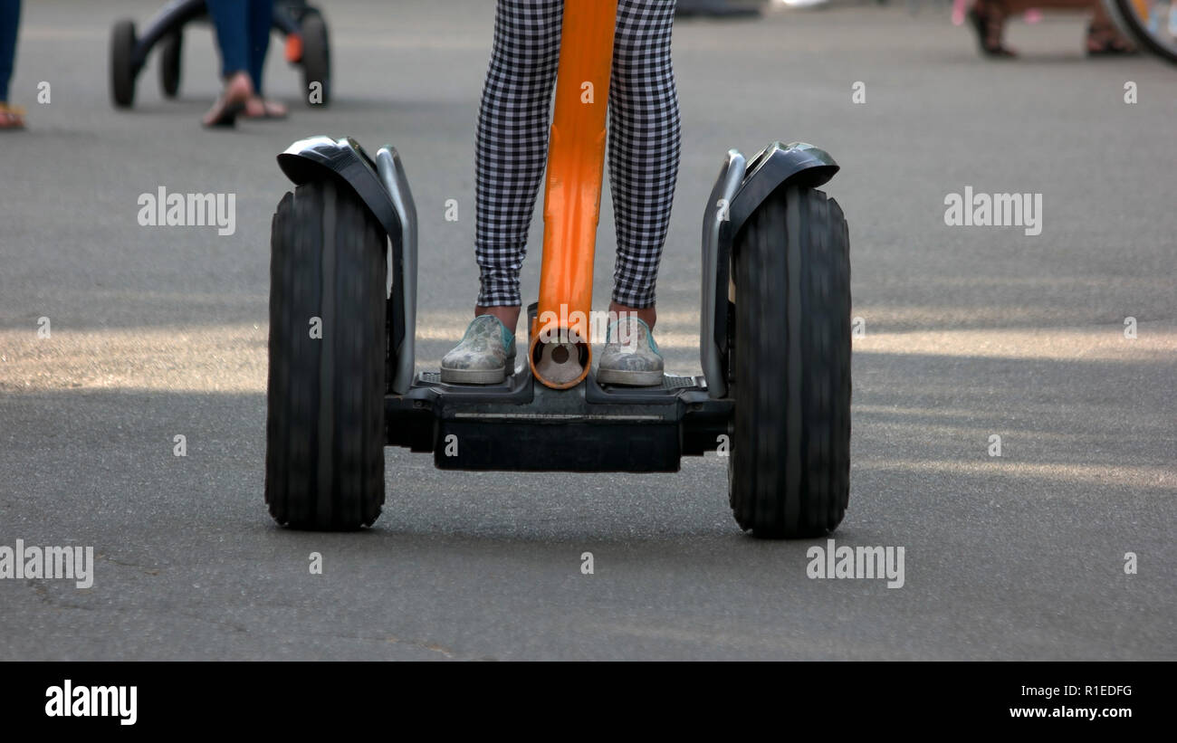 Girl driving segway on asphalt road Stock Photo - Alamy