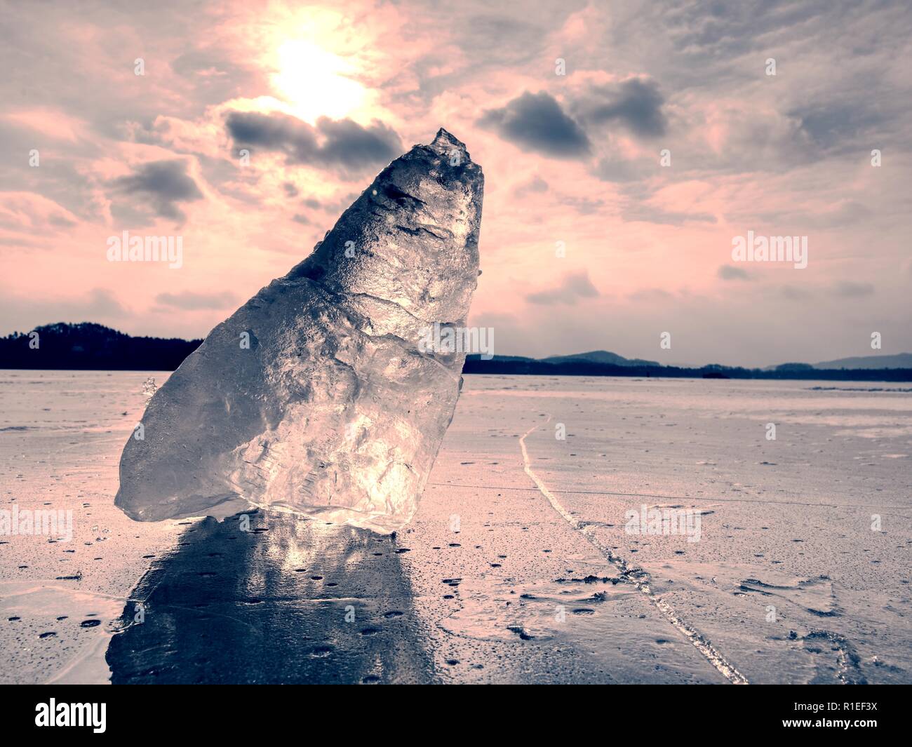 Ice breaking. Floe on frozen lake with sunset sky background Stock ...