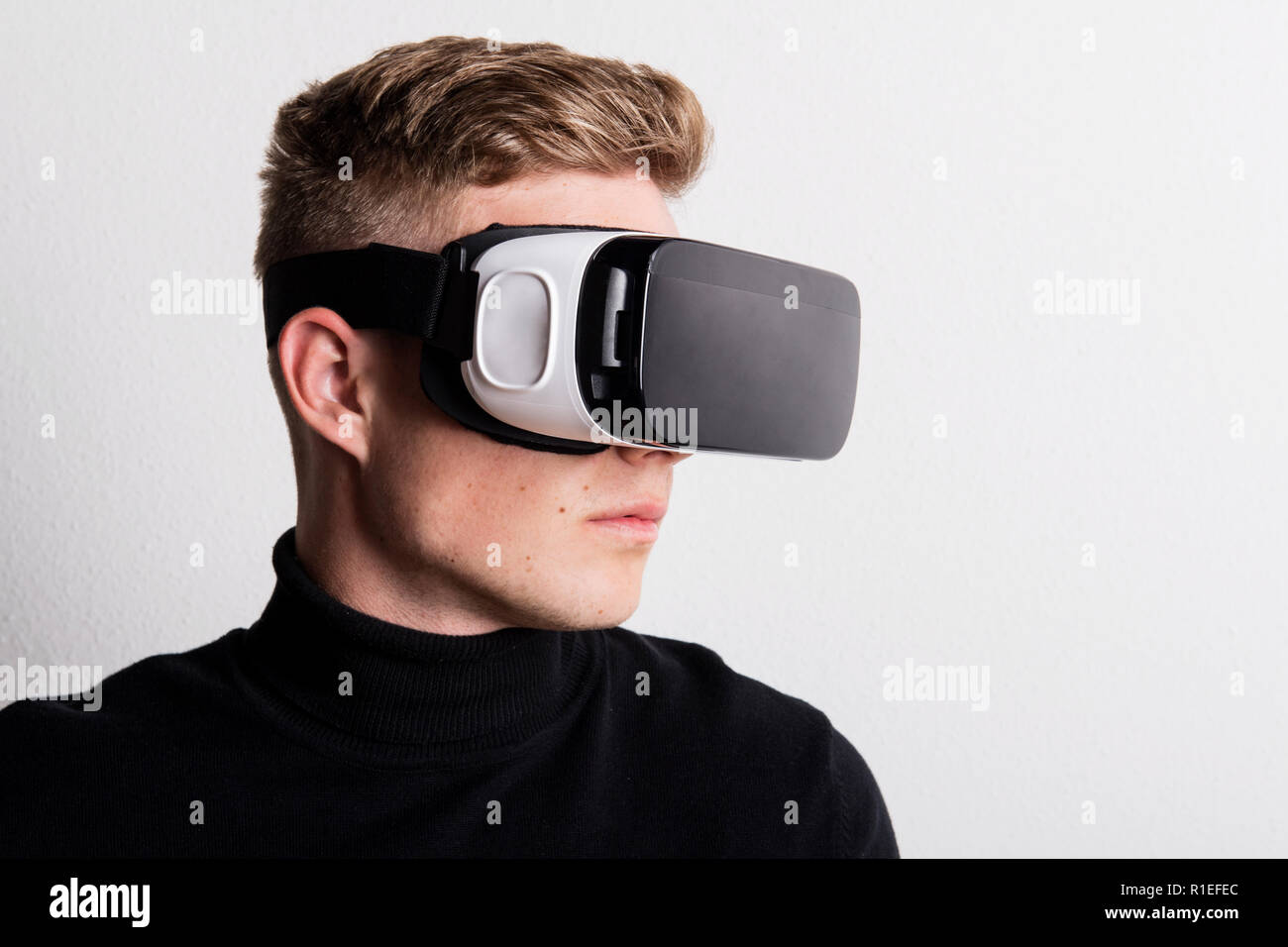 Portrait of a young man with virtual reality goggles in a studio Stock ...