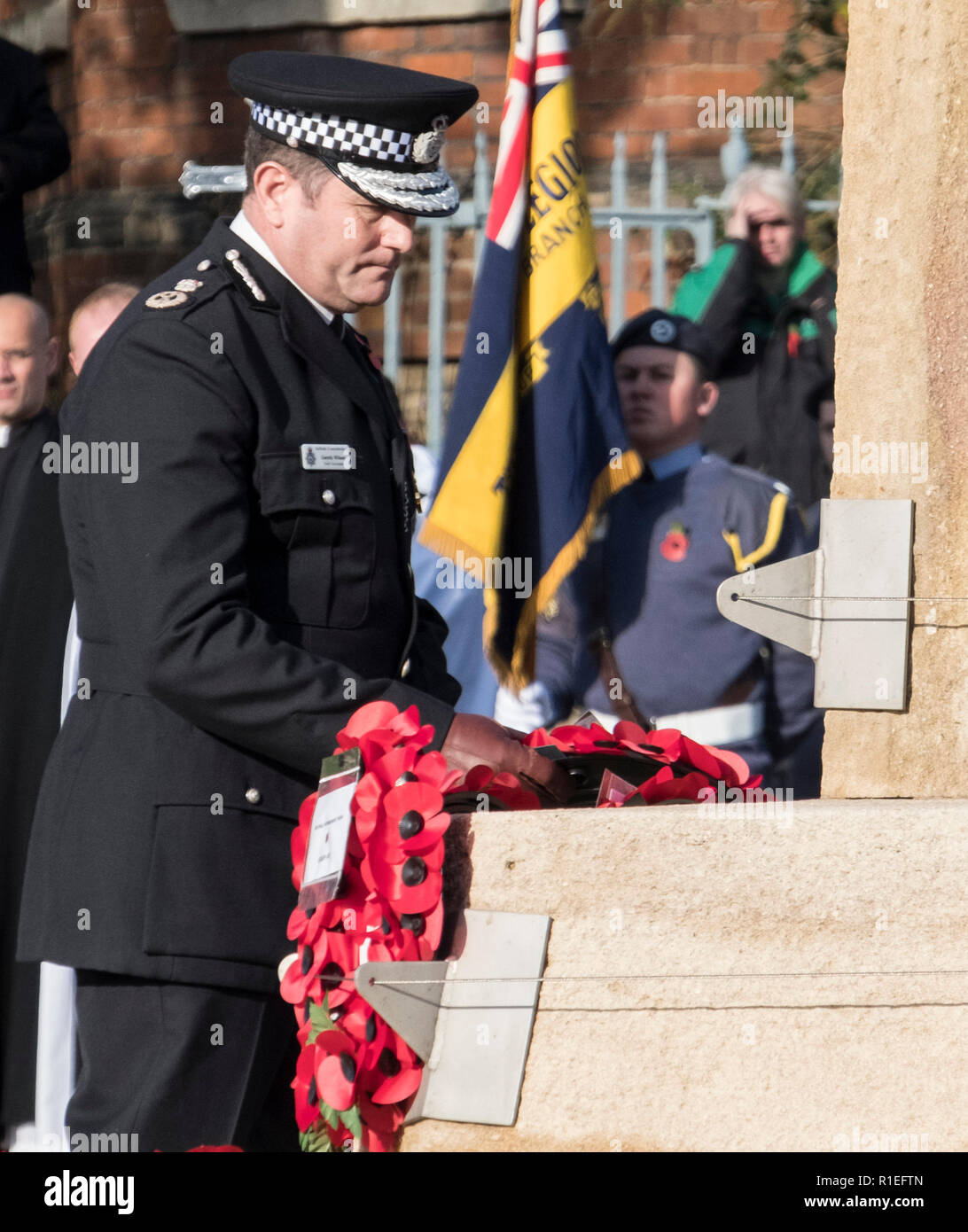 A police officer lays a reef during the Remembrance Sunday parade ...
