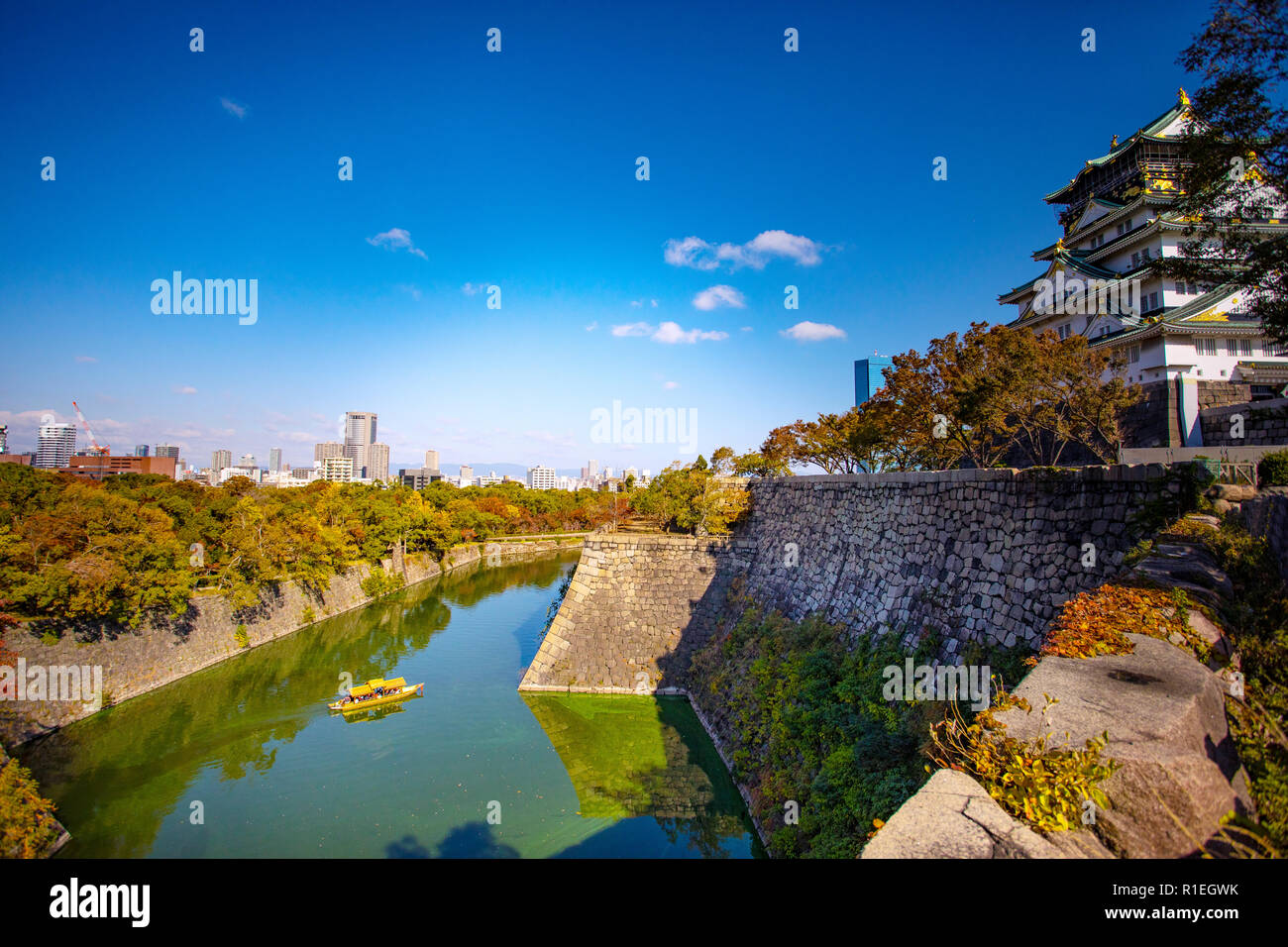 side view of osaka castle and urban skyline against beautiful clear ...
