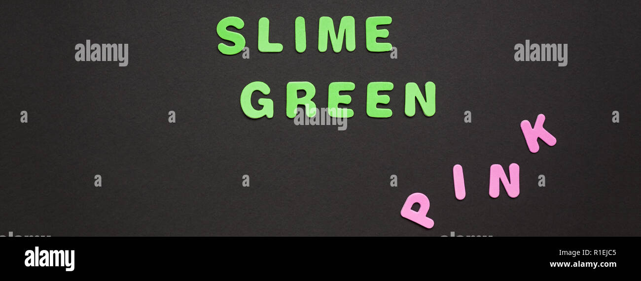 Creative colorful text made from plastic letters Slime green writing on ...