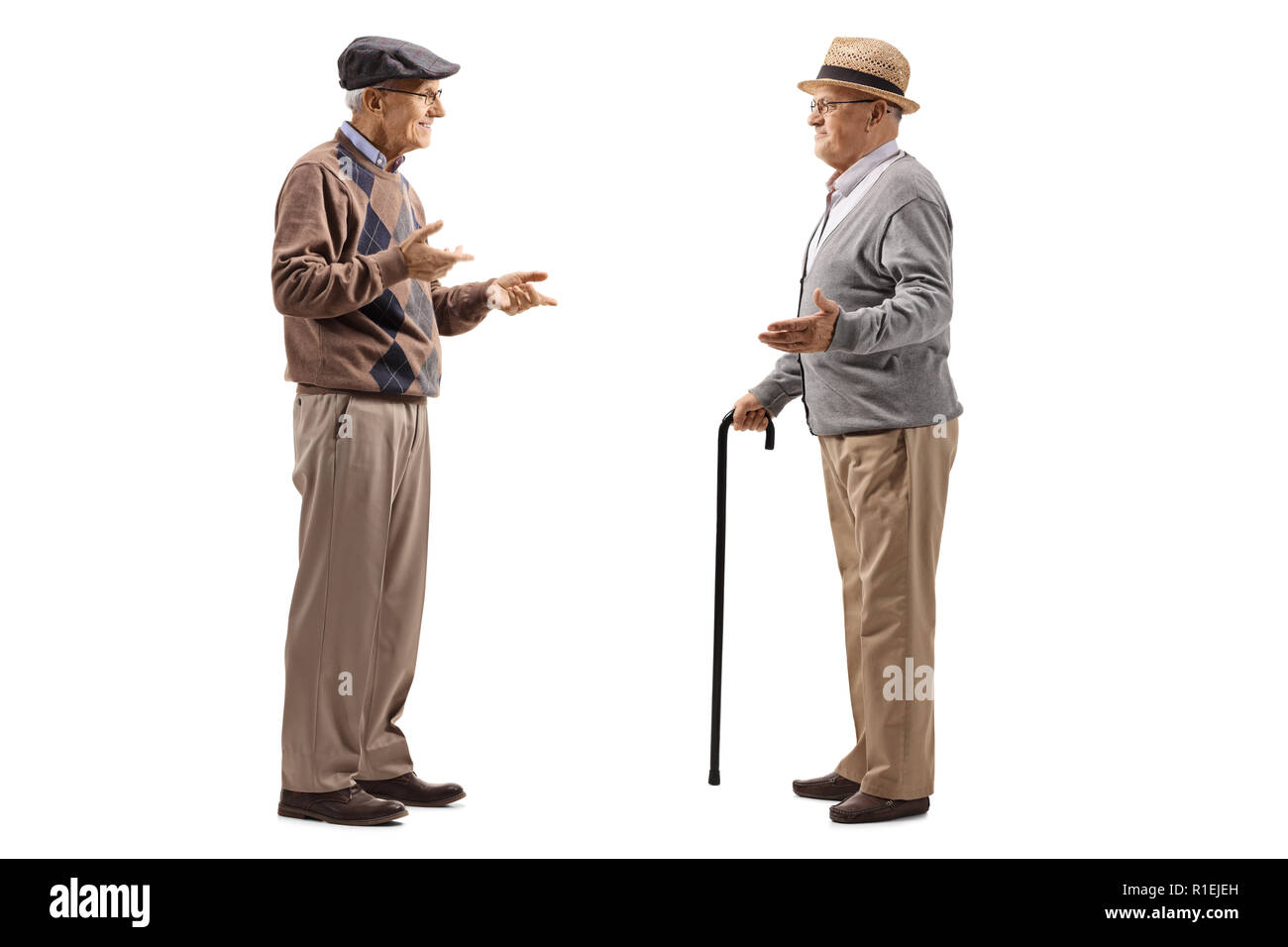 Full length shot of two elderly men having a conversation isolated on ...