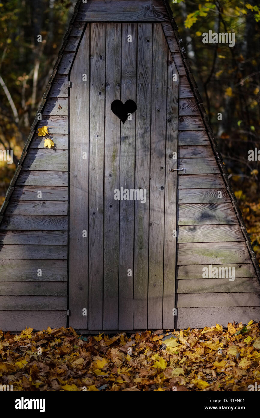 old wooden countryside toilet house with heart shaped hole in the door ...