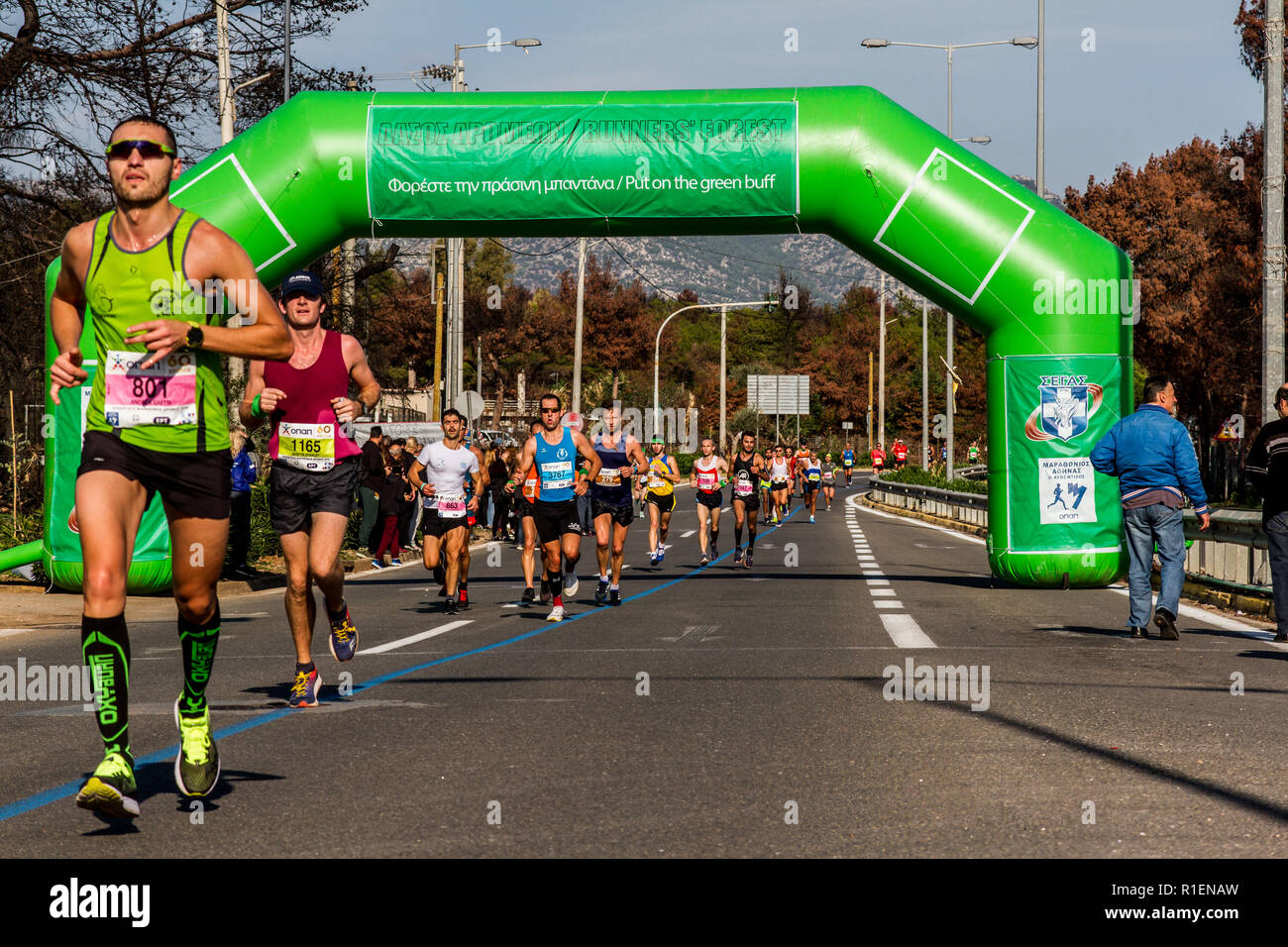 Athens, Greece. 11th Nov, 2018. Runners pass under the bridge that was ...