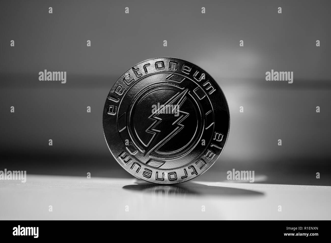 Electroneum cryptocurrency physical coin placed against white window ...