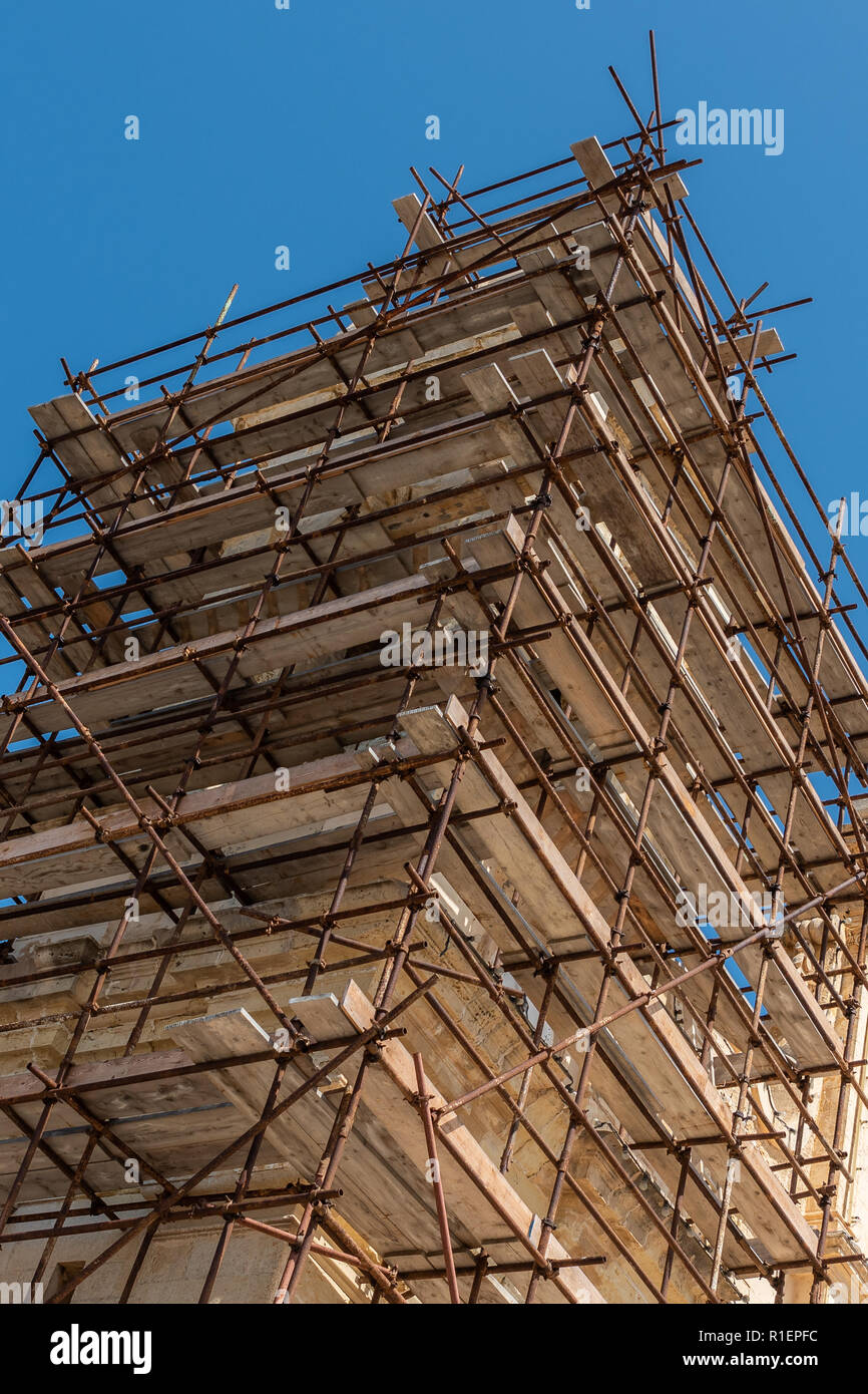 Construction scaffold to restore church limestone. Malta. Vertical ...