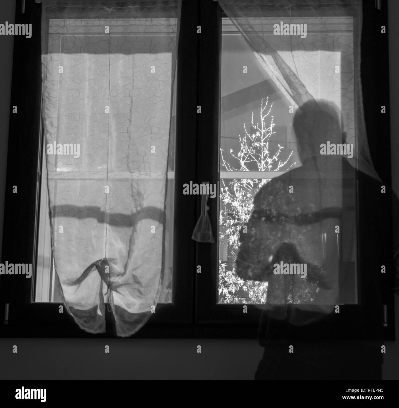 Light outside and man shadow inside the window in the house Stock Photo ...