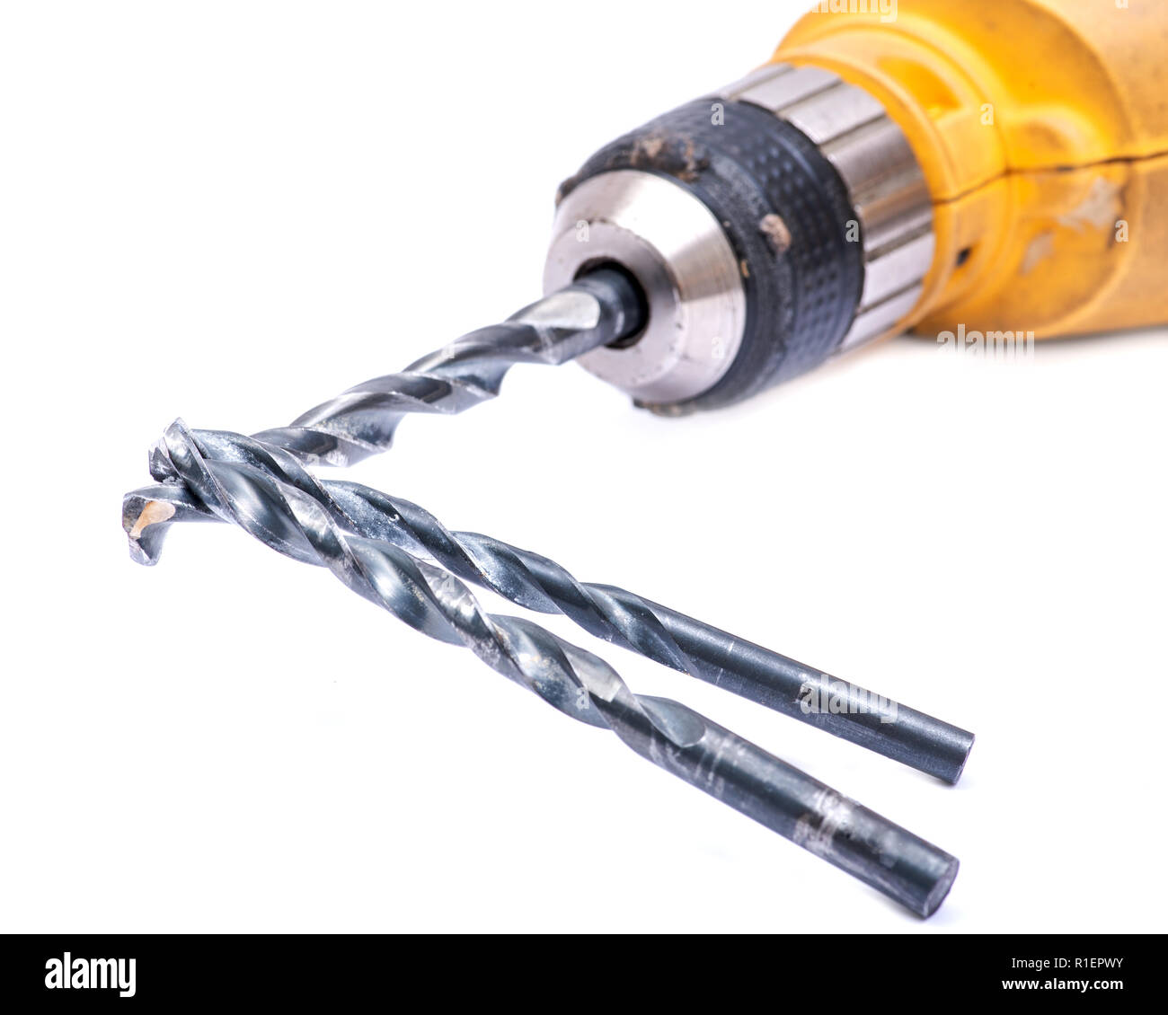 Old drill gun with used drill bit isolated on white background Stock ...