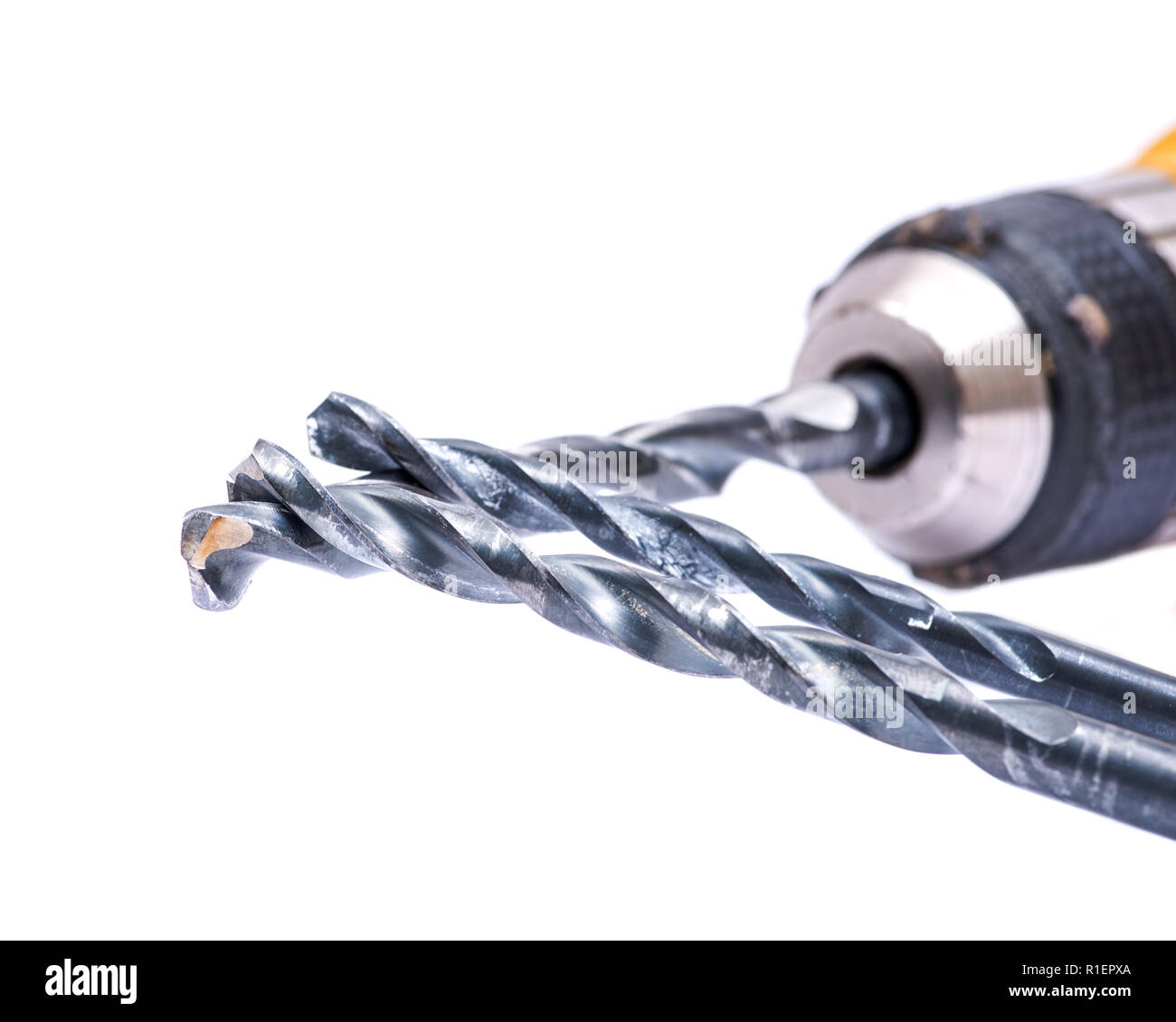 Old drill gun with used drill bit isolated on white background Stock ...
