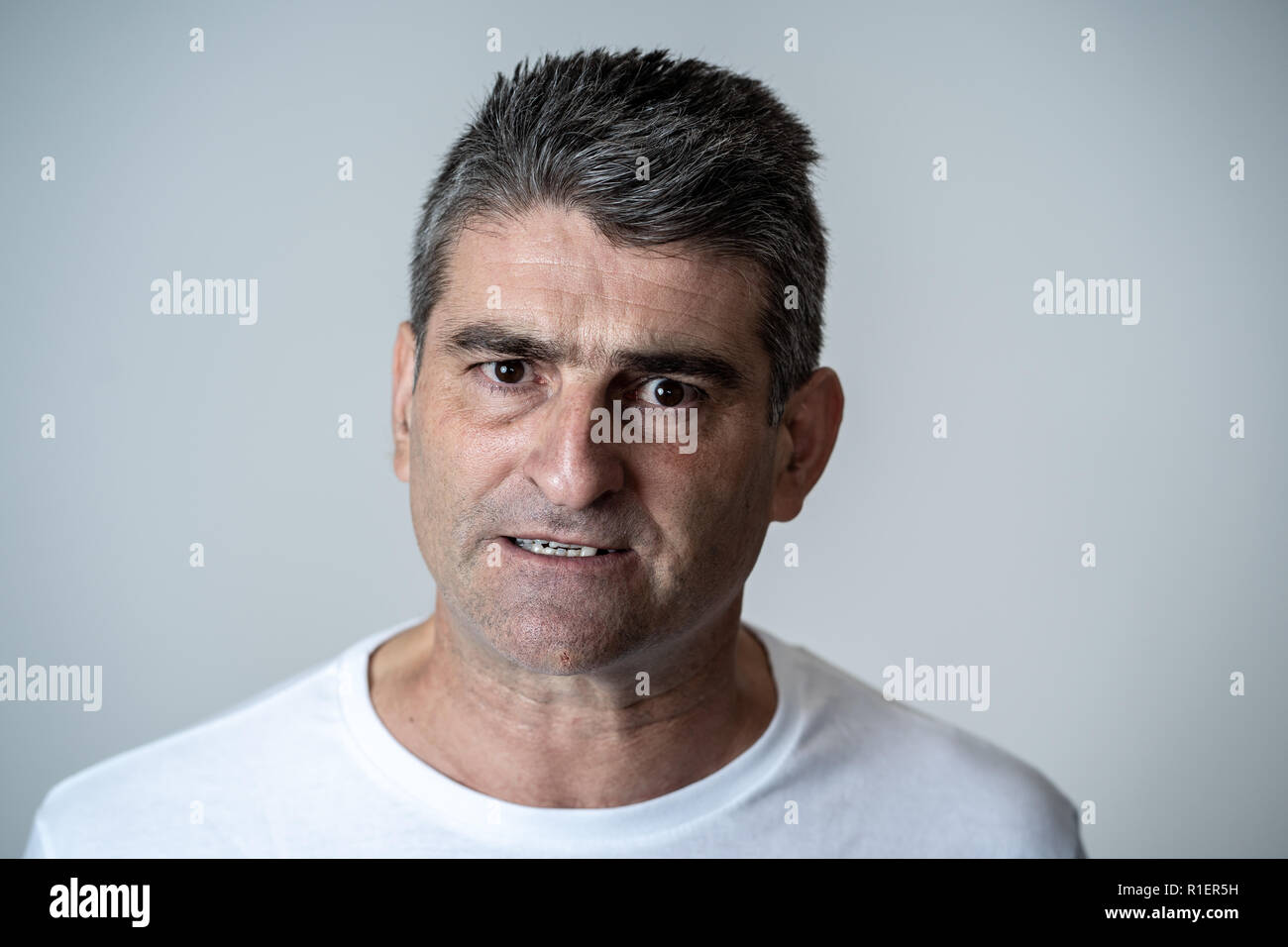 Portrait of a mature 40s to 50s white angry and upset man looking ...