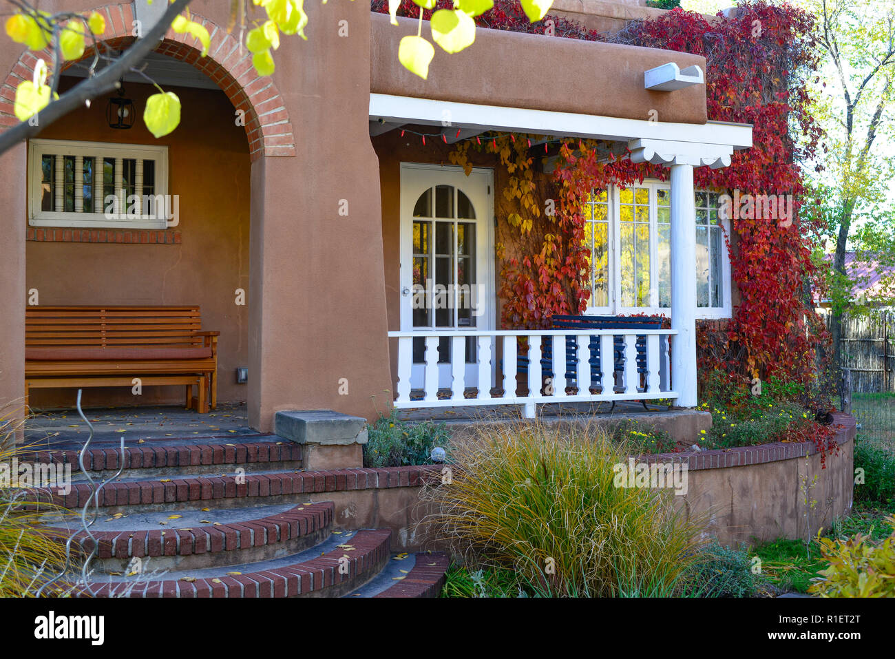 A charming territorial architectural style house with ivy climbing the ...