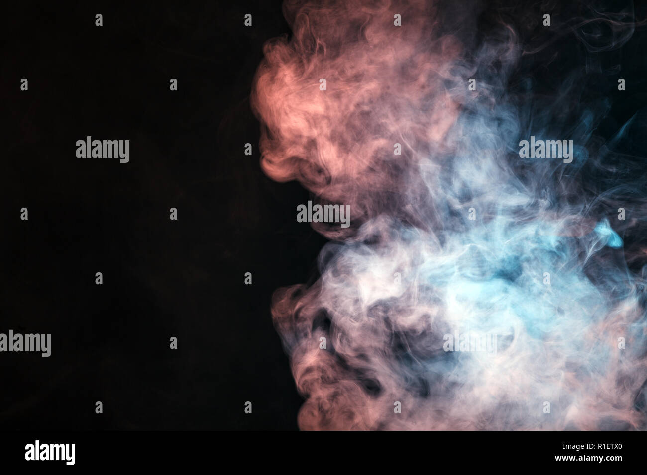 Colored smoke on a black background. The concept of a light show at a ...