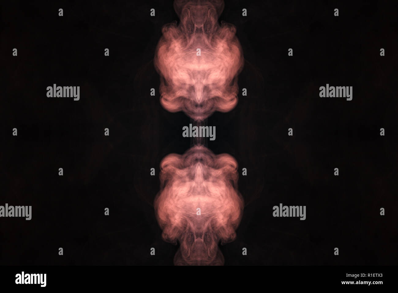 Abstract thick colored smoke on a black background with a monster face ...