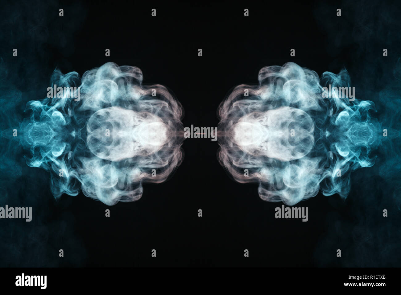 Abstract thick colored smoke on a black background with a monster face ...
