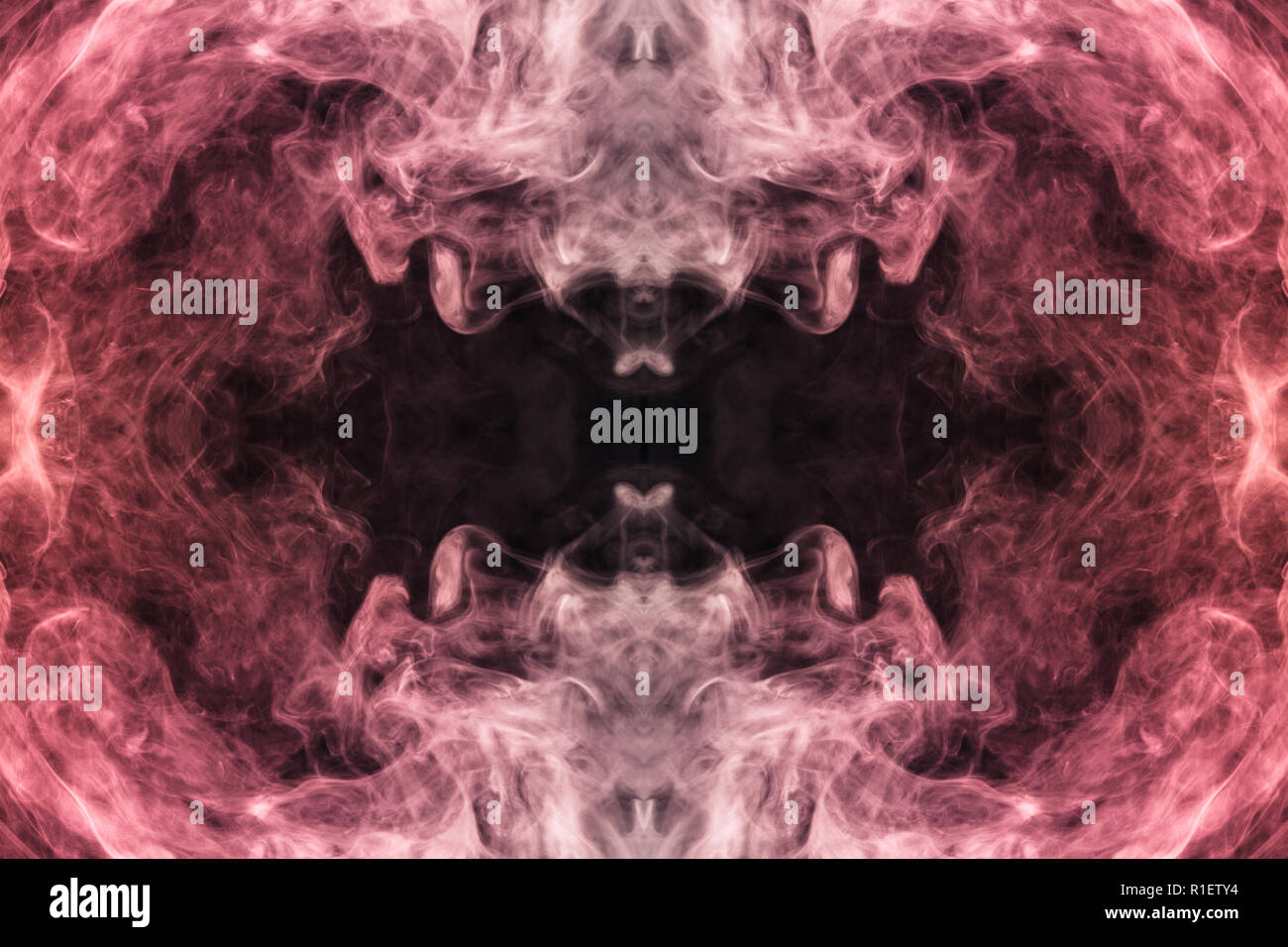 Abstract thick colored smoke on a black background with a monster face ...