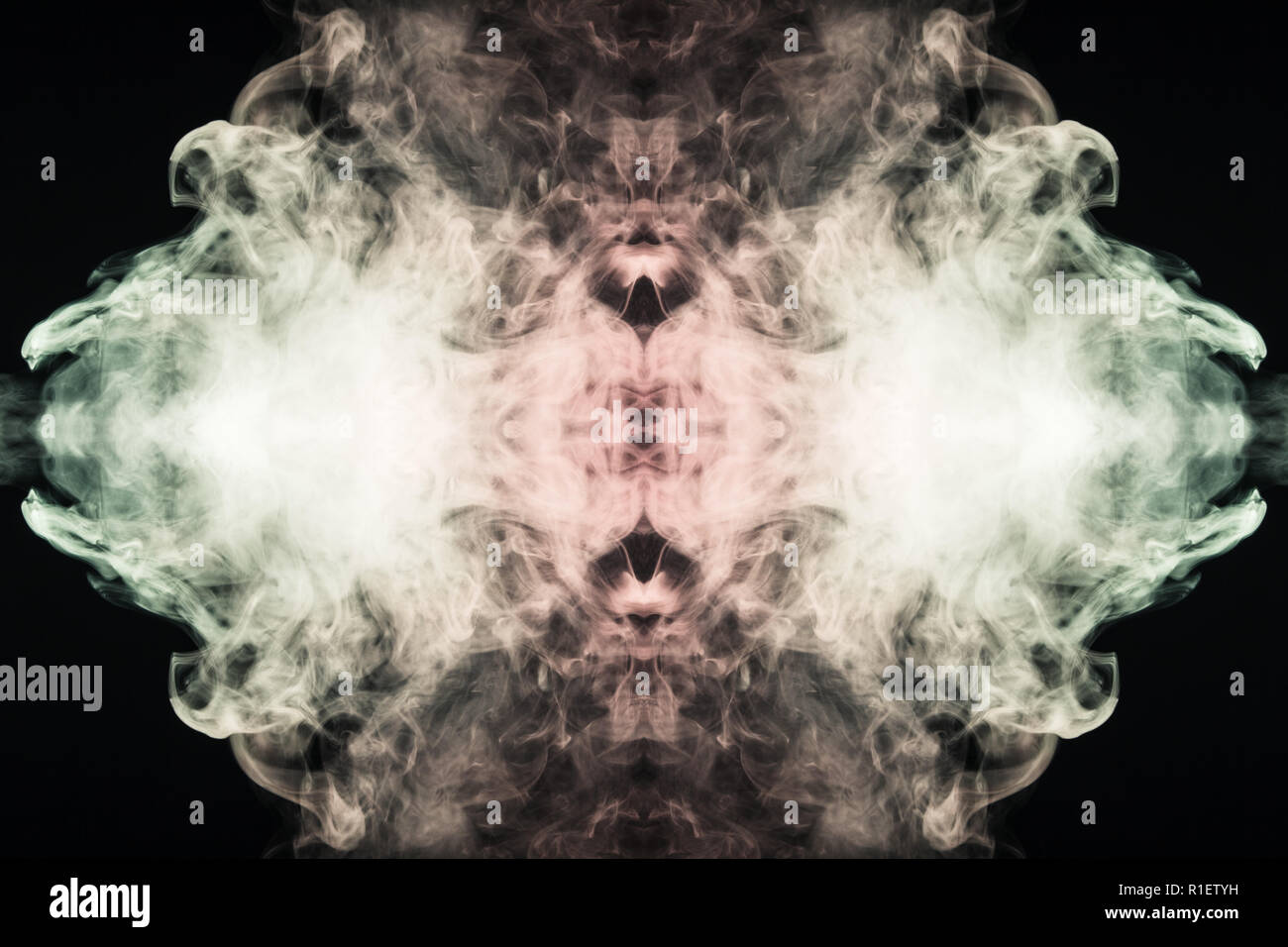 Abstract thick colored smoke on a black background with a monster face ...