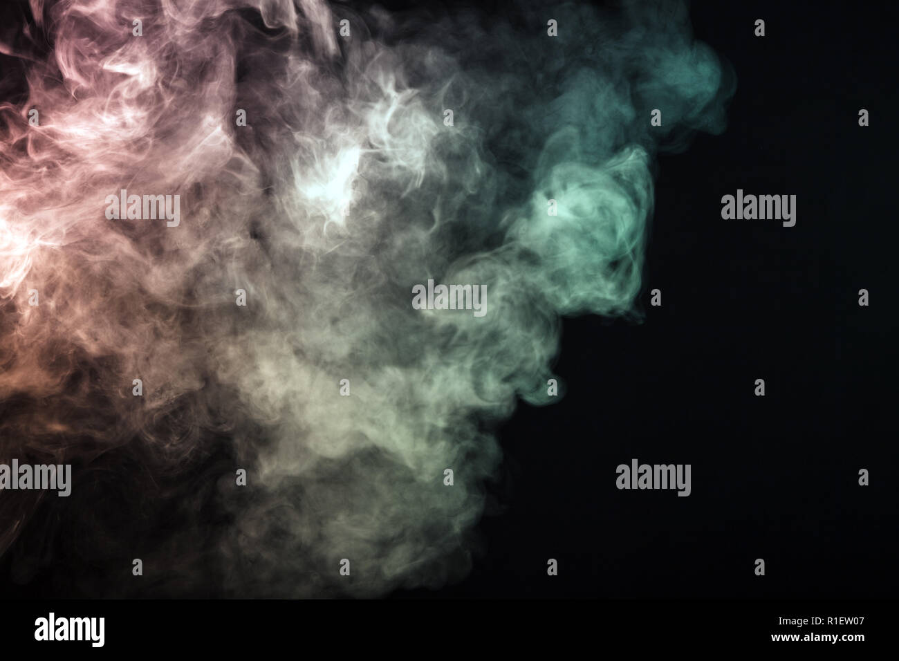 Colored smoke on a black background. The concept of a light show at a ...