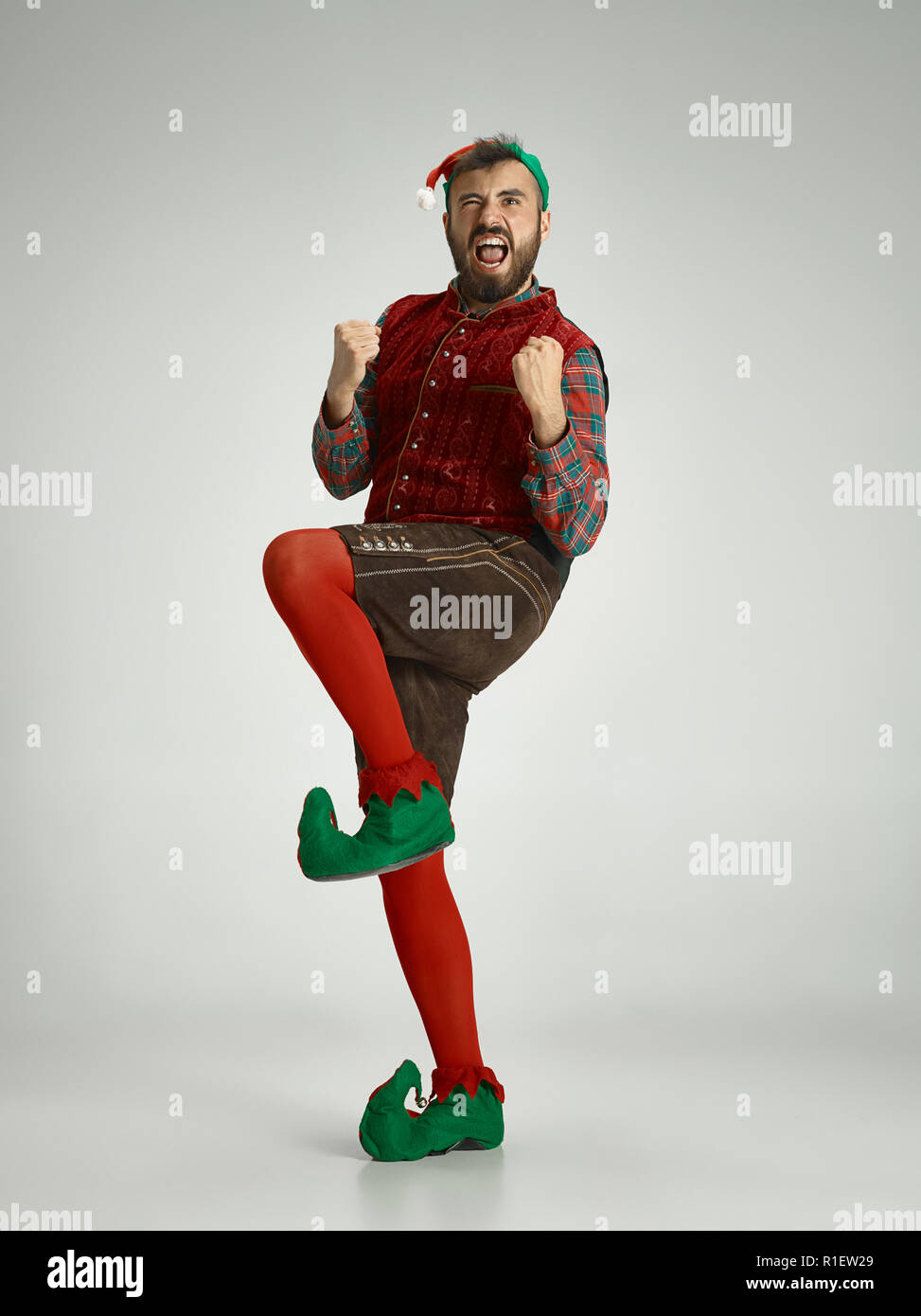 The happy smiling friendly man dressed like a funny gnome or elf posing ...