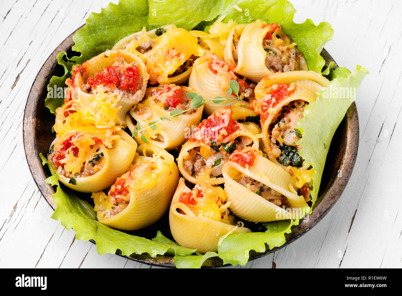 Italian style stuffed pasta shells with meat on a white background ...