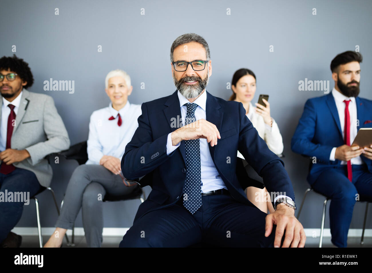 Group of business people with leader at front Stock Photo - Alamy
