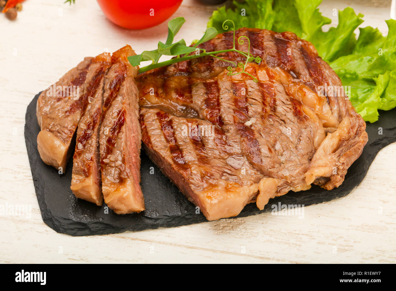 Grilled Rib eye steak with sauce Stock Photo - Alamy