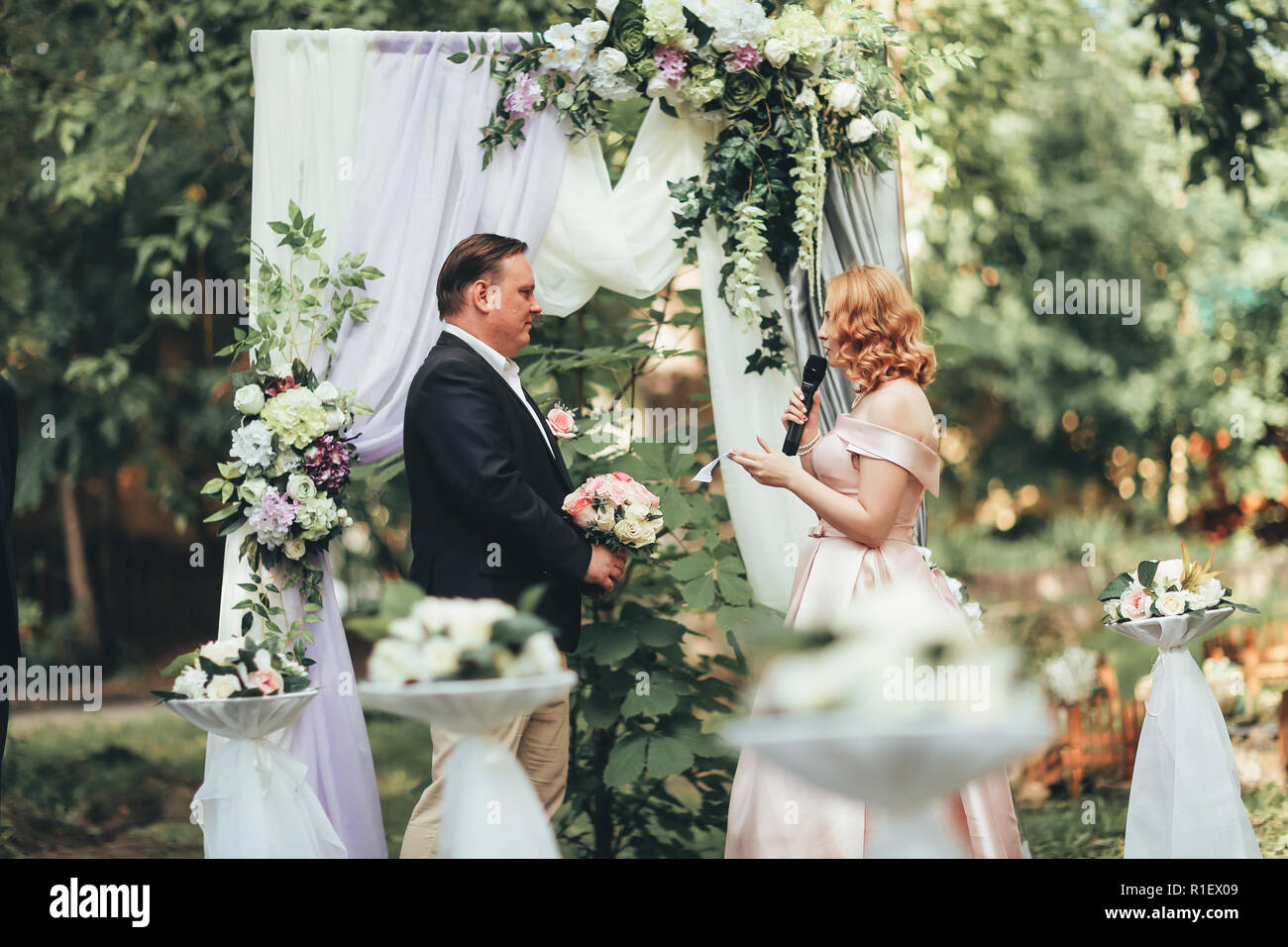 bride and groom on wedding ceremony on background nature Stock Photo ...