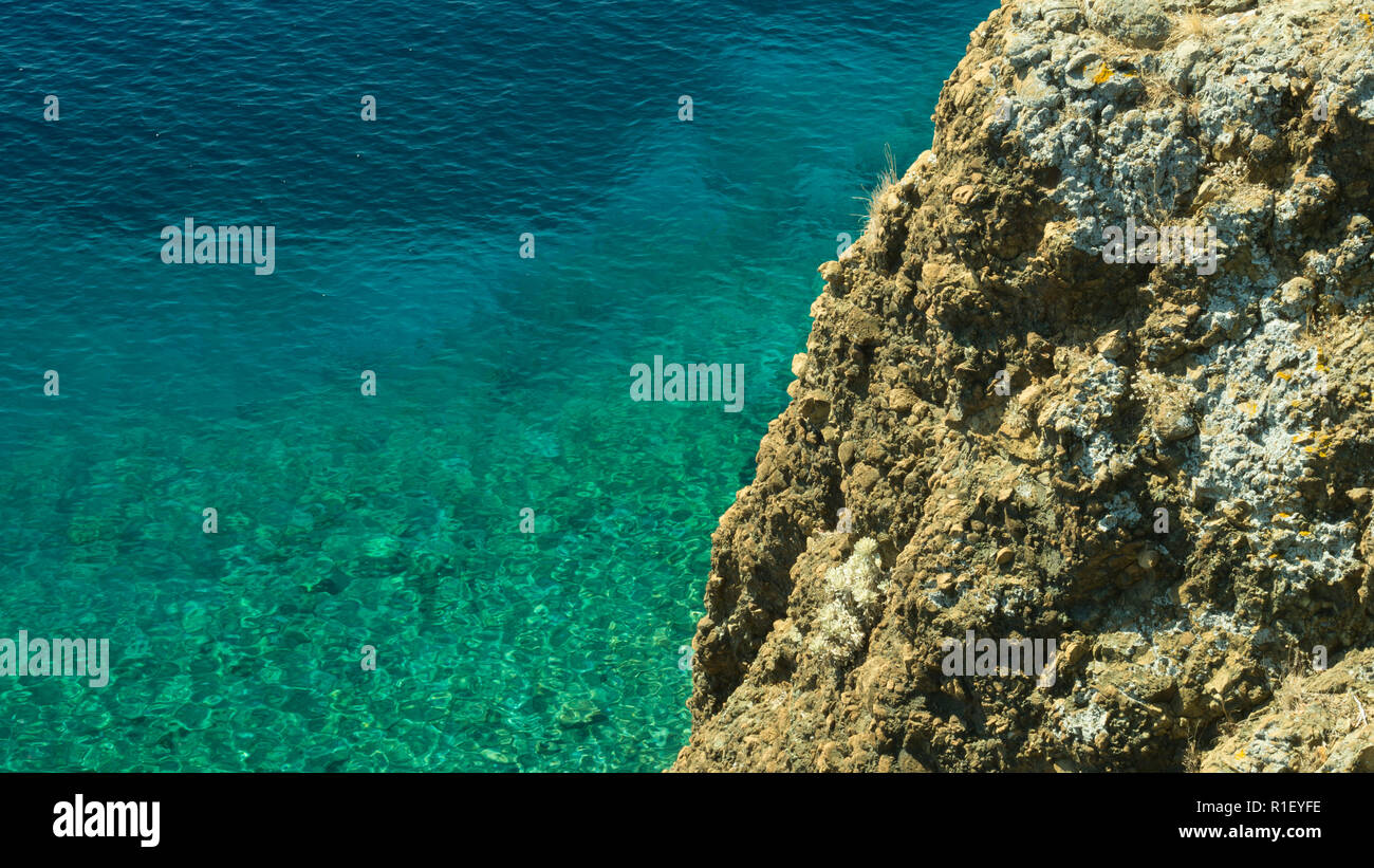 Mountain and sea. transparent water. rocky cliff background Stock Photo ...