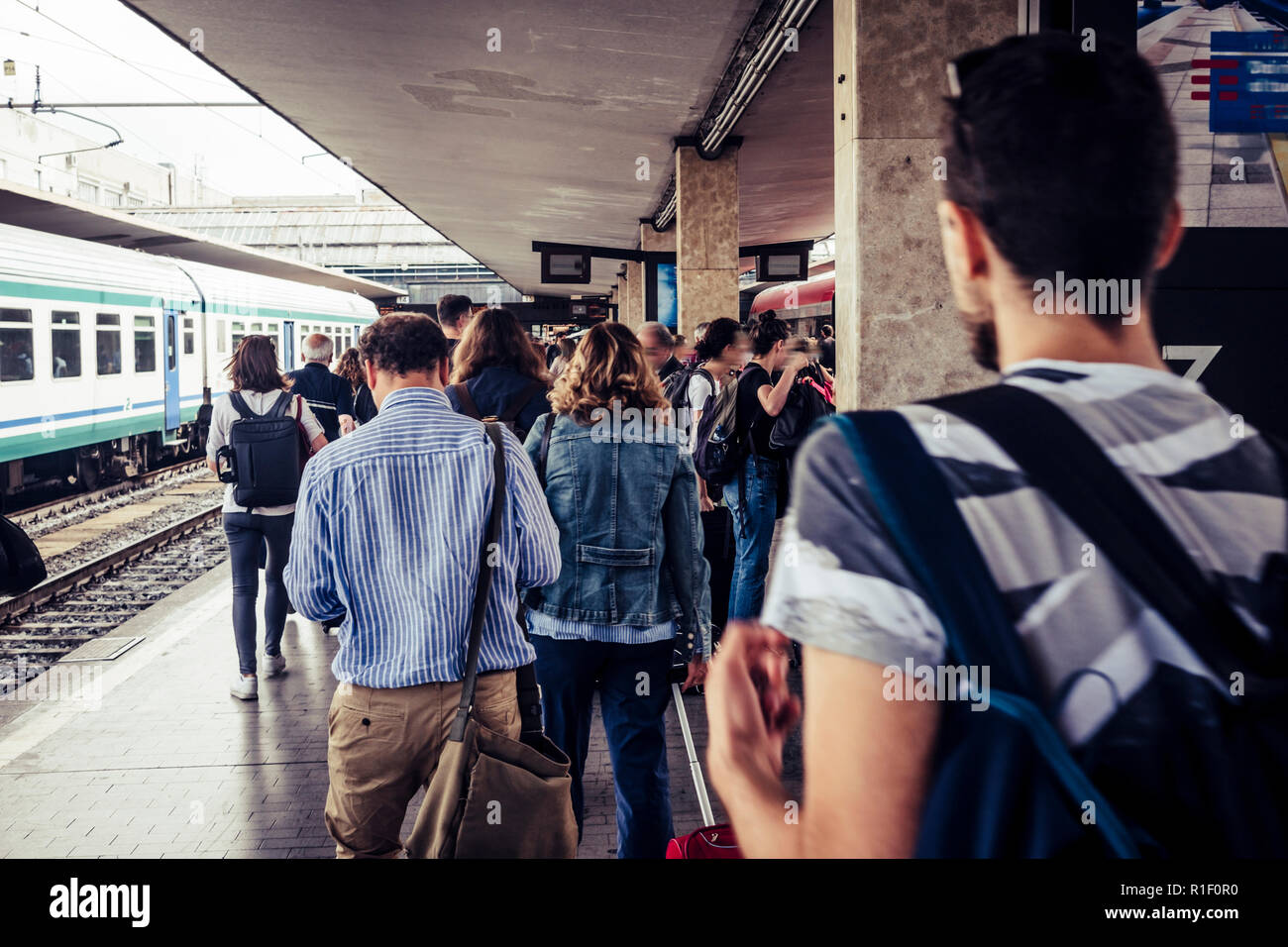 Crowd of people inside the train station of Milan Centrale going out to ...