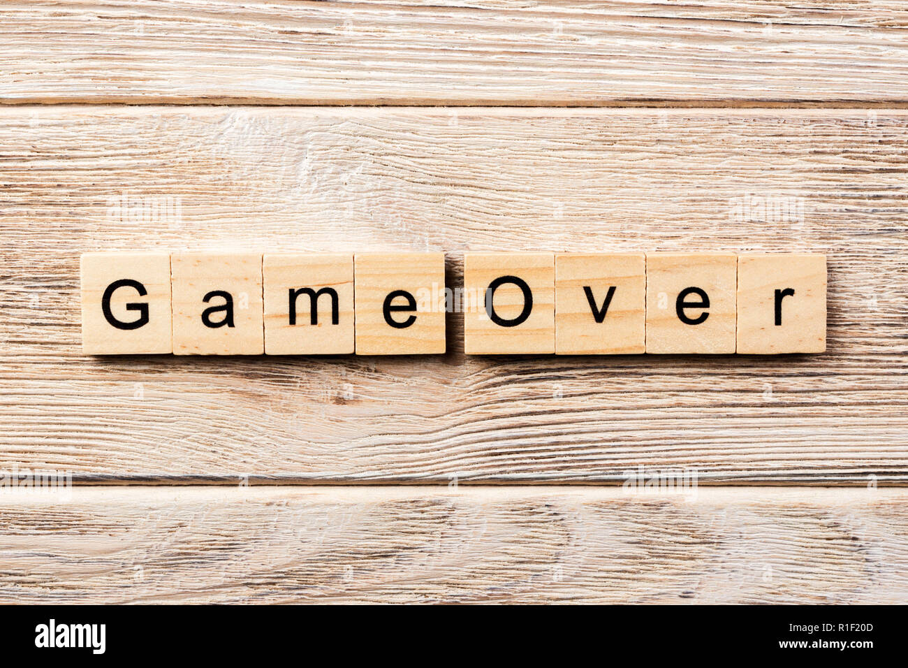 game over word written on wood block. game over text on table, concept ...