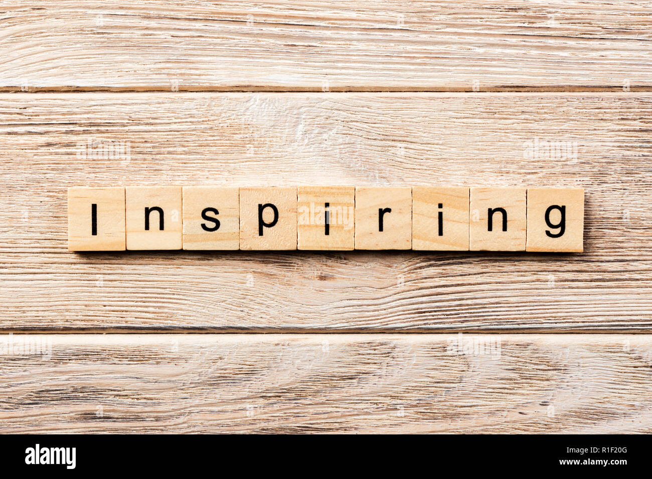 inspiring word written on wood block. inspiring text on table, concept ...