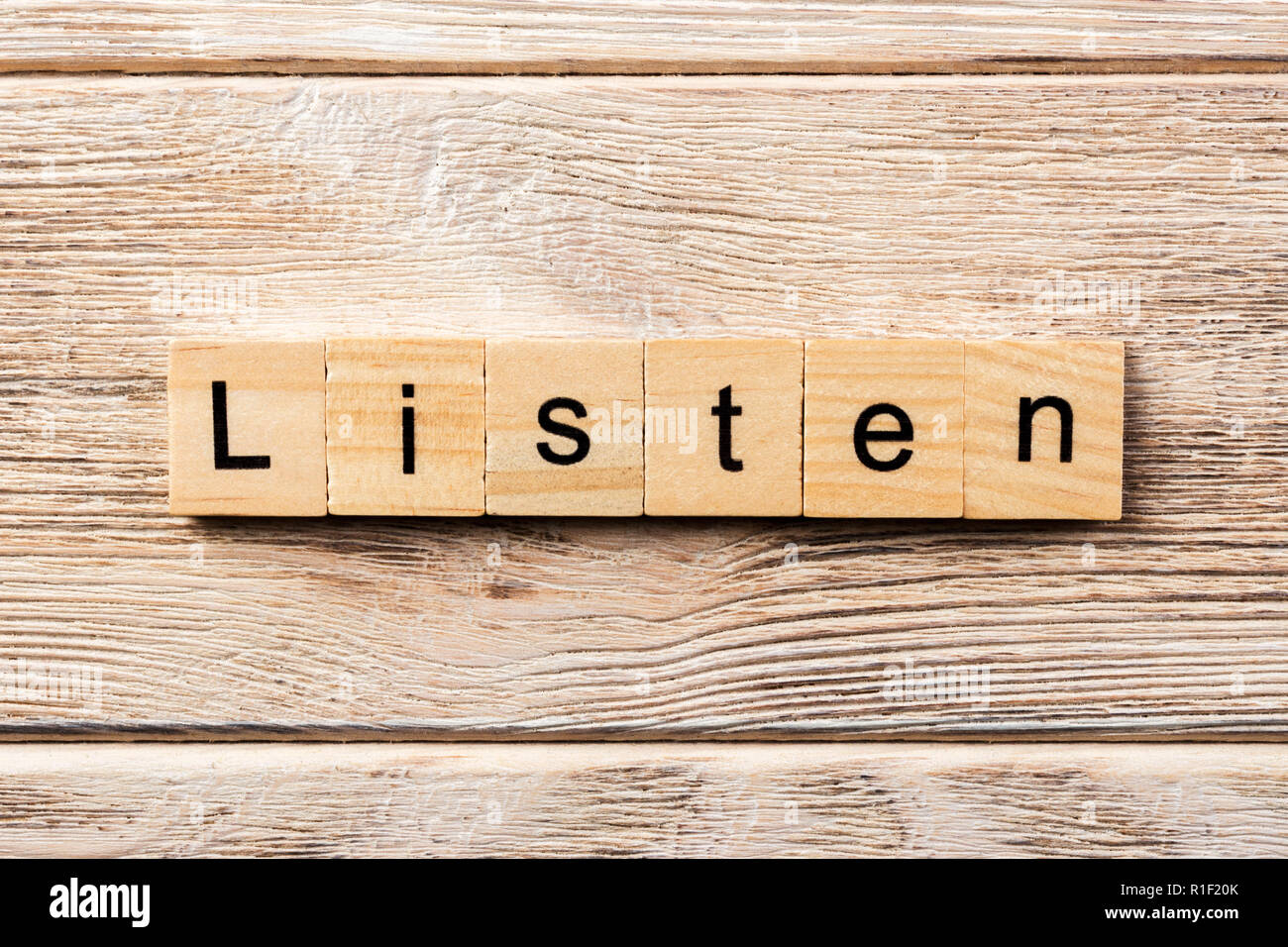 listen word written on wood block. listen text on table, concept Stock ...