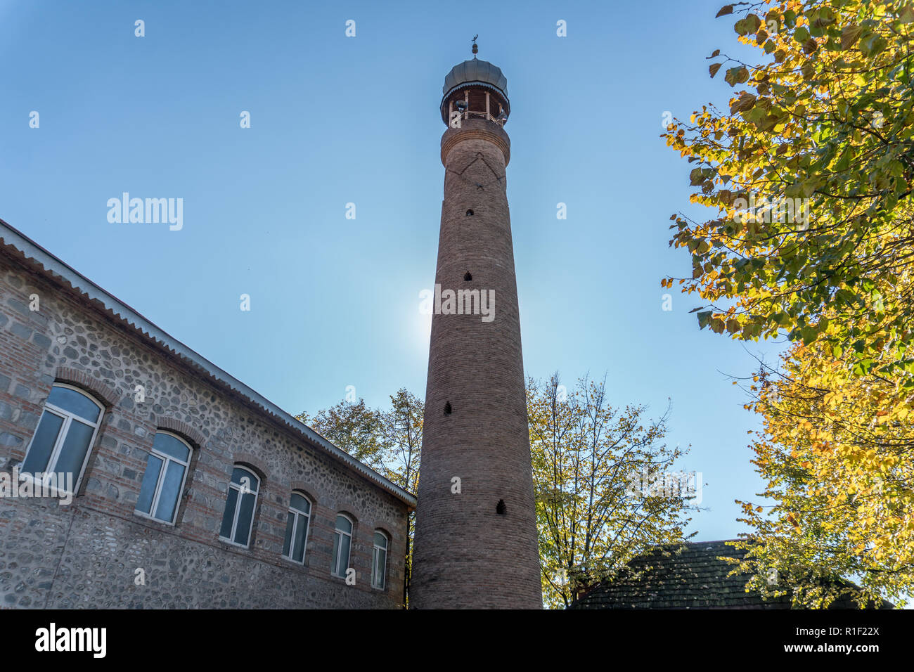 Juma Mosque minaret against solid blue skey Stock Photo - Alamy