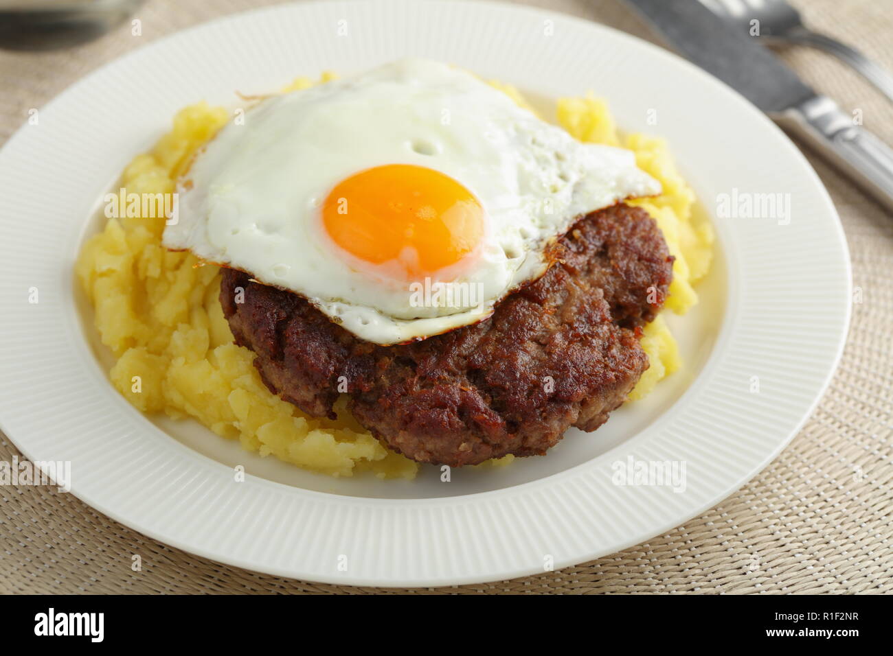 Hamburg steak with fried egg and mashed potato Stock Photo - Alamy