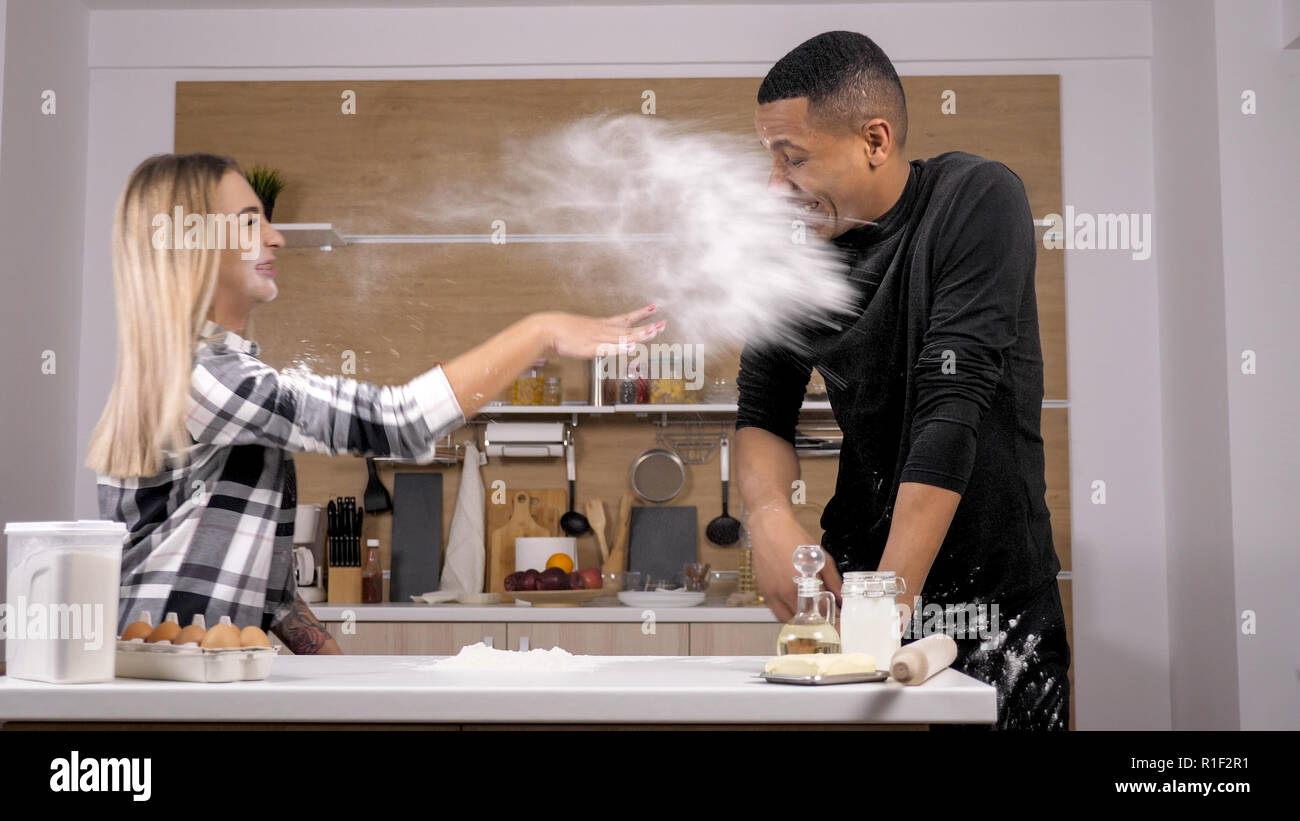 Beautiful couple having fun while cooking their romantic dinner. Strong ...