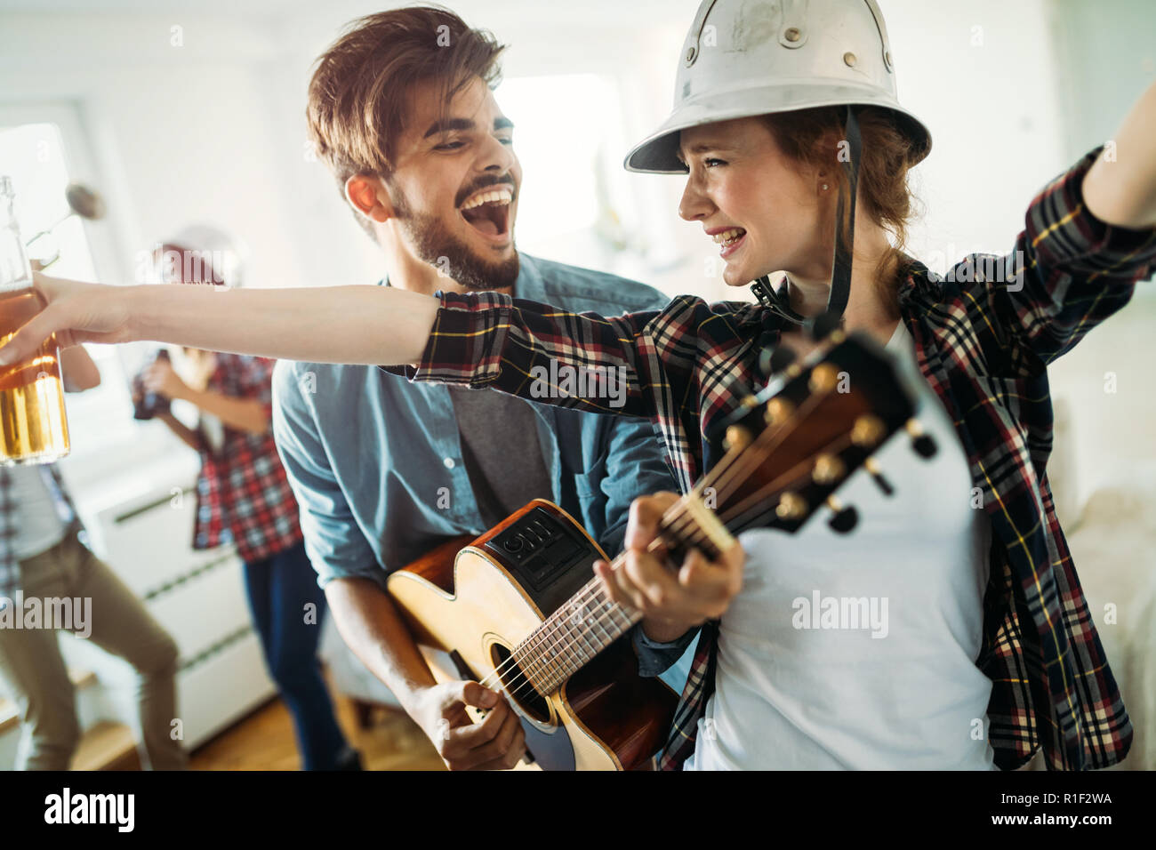 Happy young friends having fun and partying to music Stock Photo - Alamy