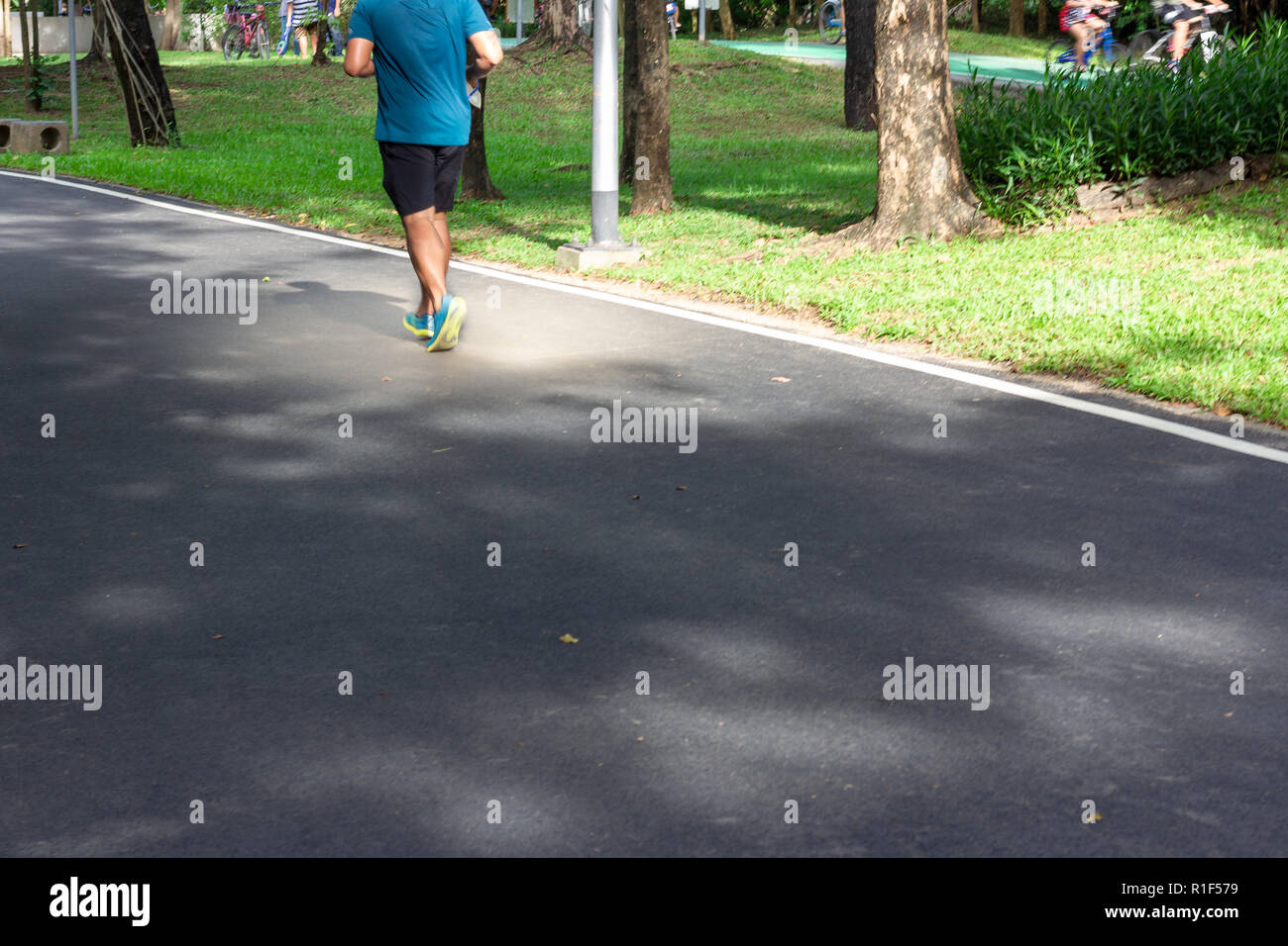 Athlete man running exercise on road in park, healthy concept Stock ...