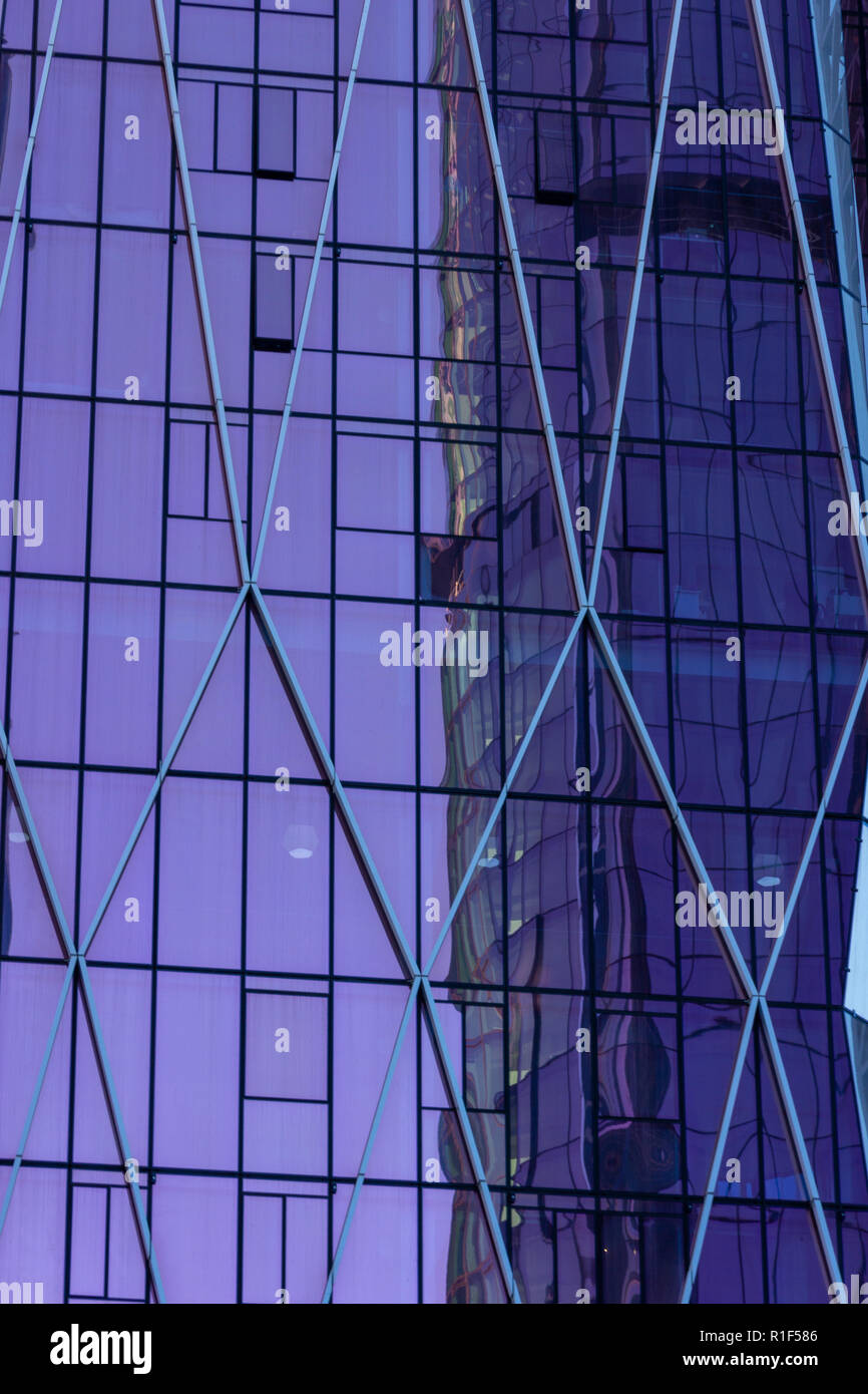 skyscraper with mirror surface which reflects other building on the ...