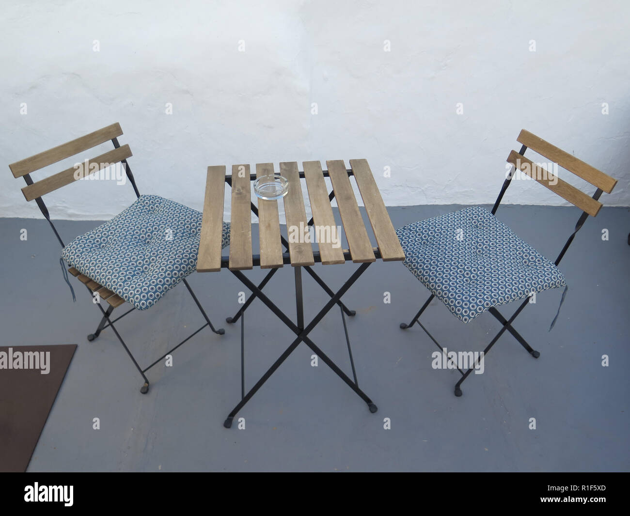 Two spindly chairs with cushions and small square table in Andalusian ...