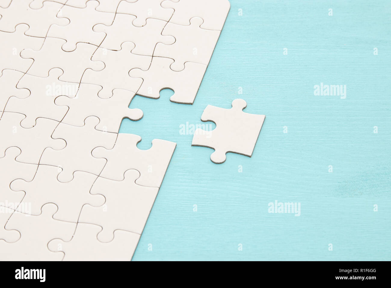 background of white puzzle with missing piece Stock Photo - Alamy