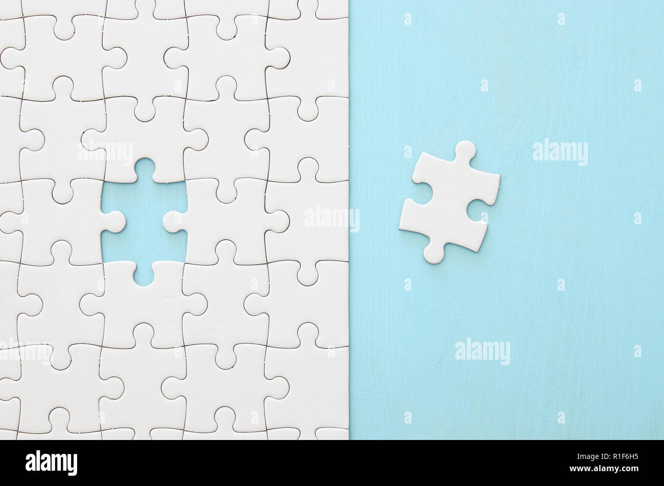 background of white puzzle with missing piece Stock Photo - Alamy