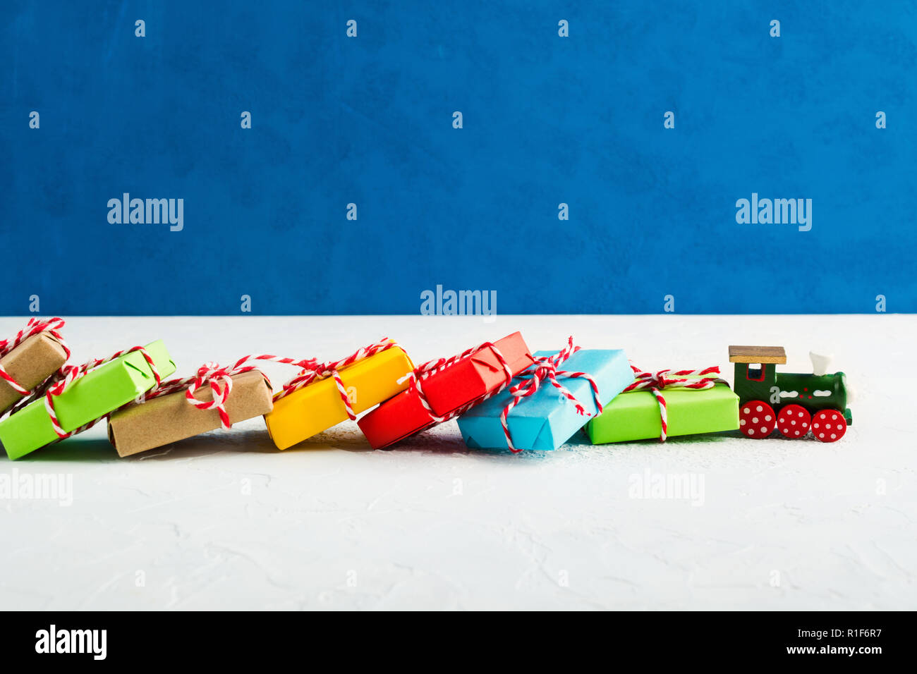 Train transports many colorful Christmas gifts in paper with blue ...