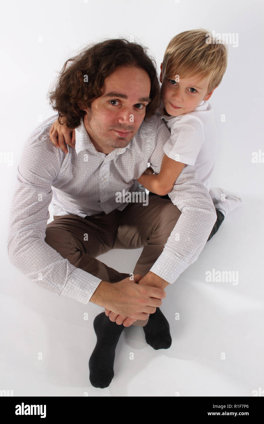 Handsome little boy hugging his father and cuddling Stock Photo - Alamy