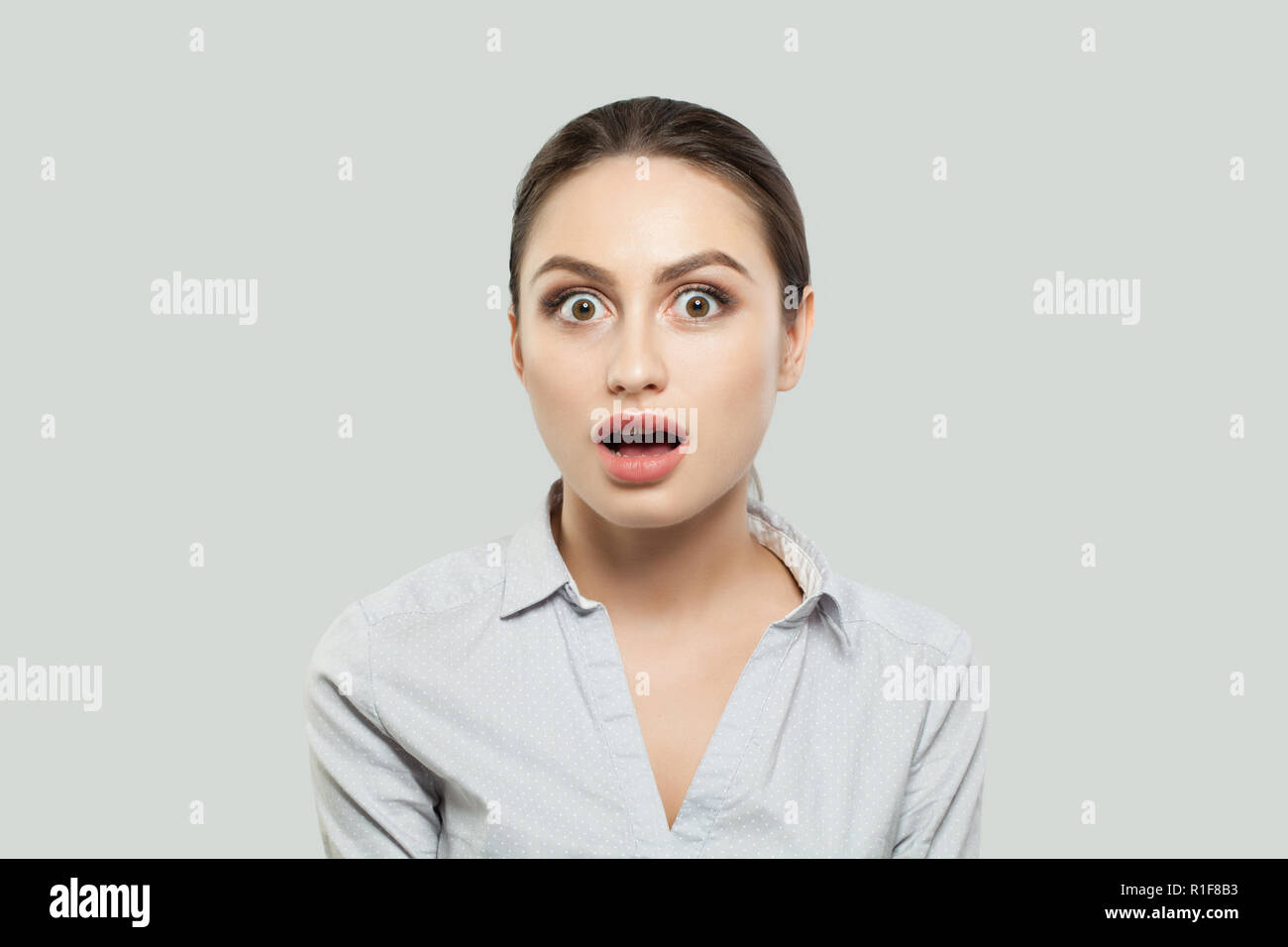 Portrait of cute surprised woman student on white background Stock ...