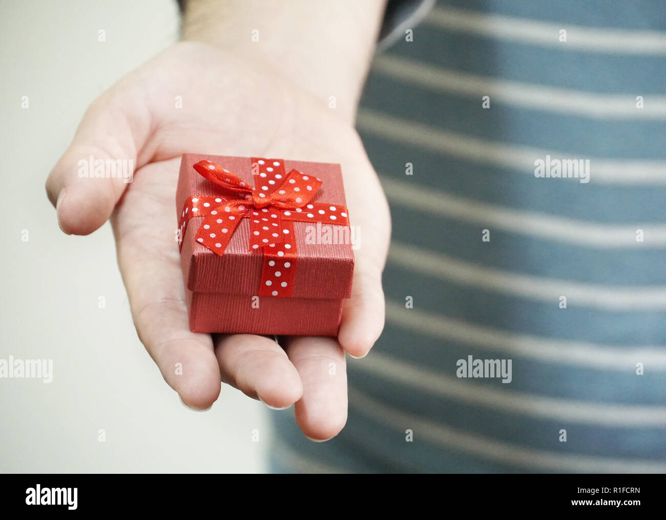 Hand with red gift hi-res stock photography and images - Alamy